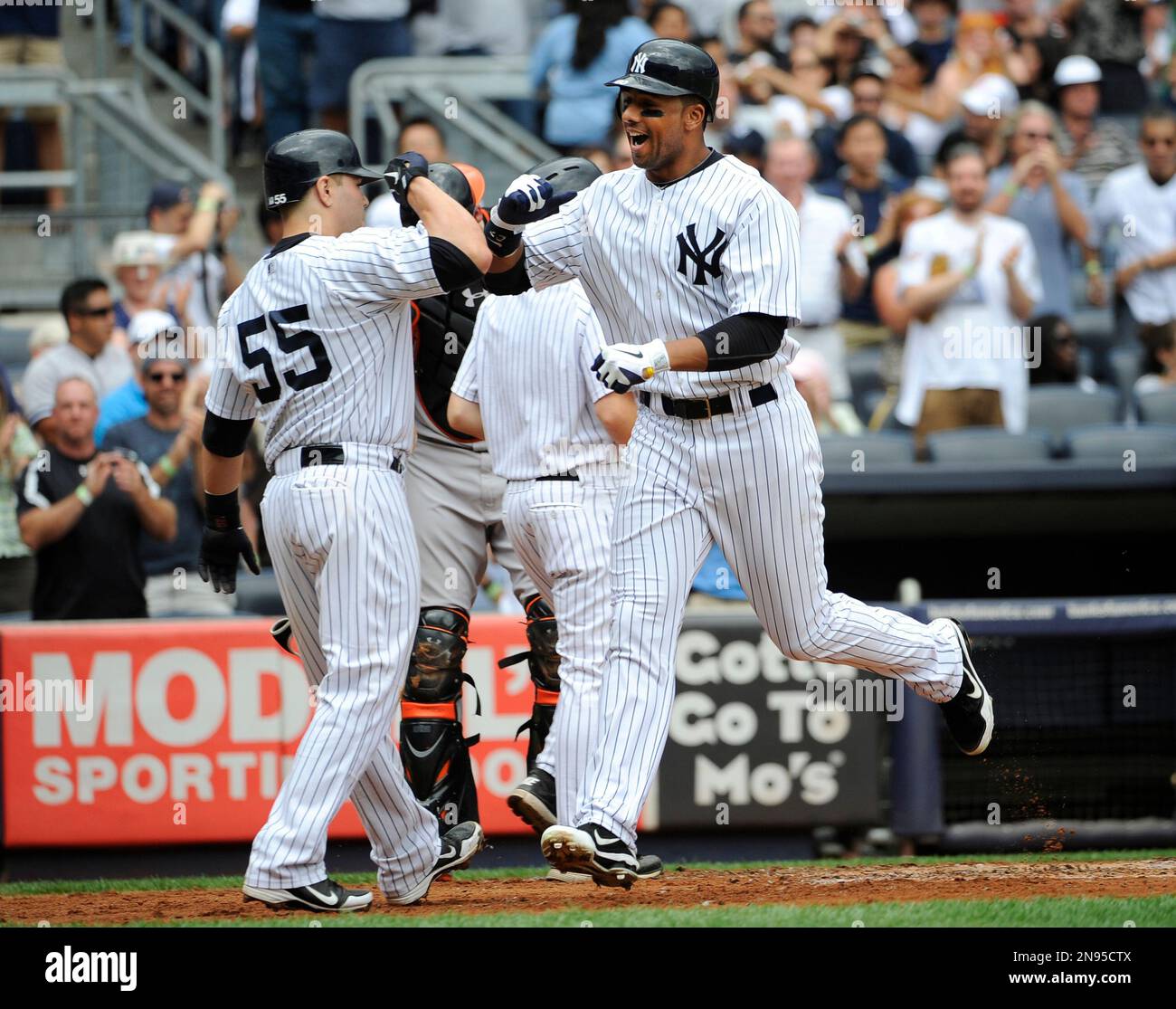 New York Yankees' Russell Martin (55) greets teammate Chris Dickerson ...