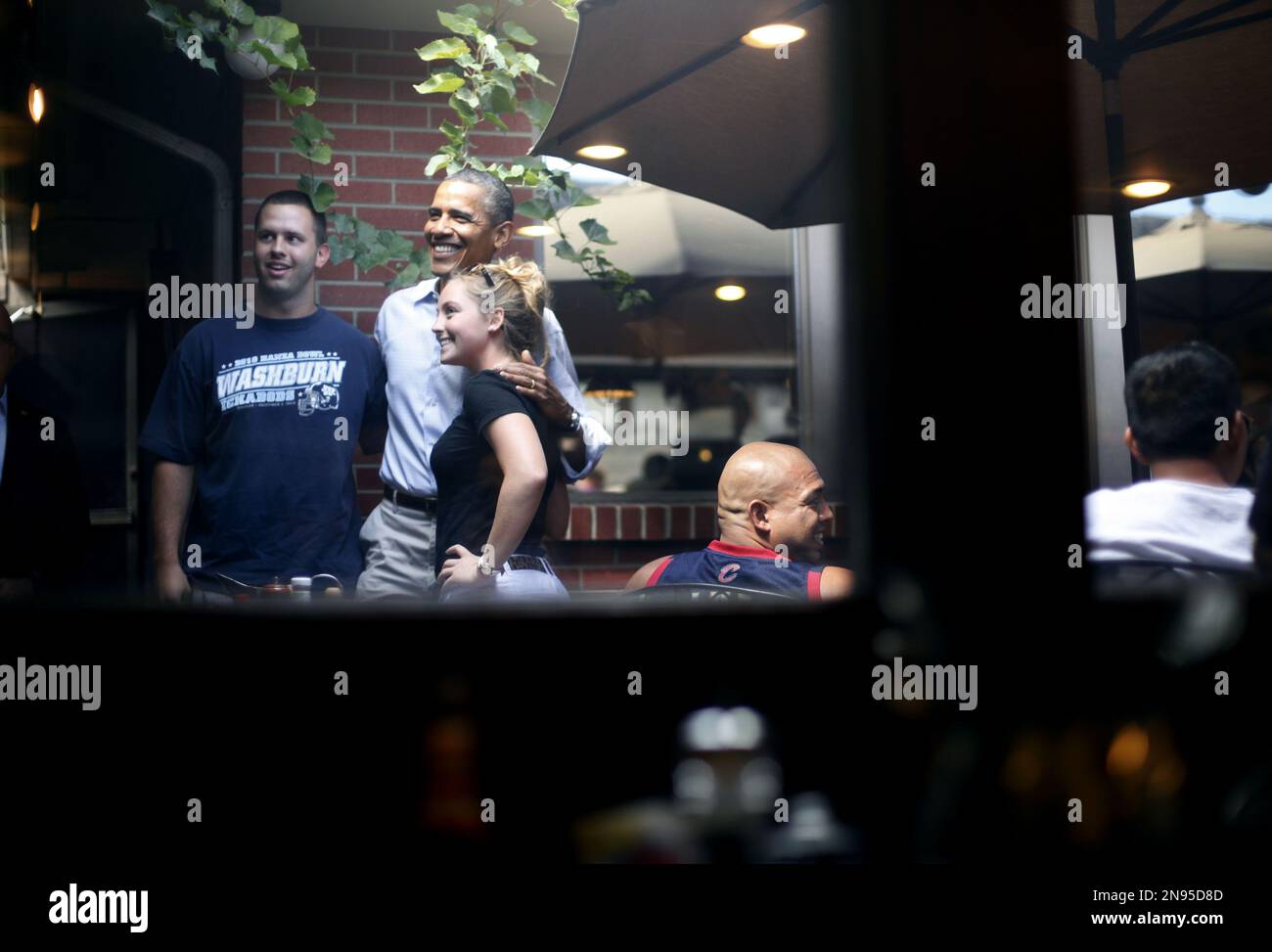President Barack Obama poses for photographs with patrons in the ...