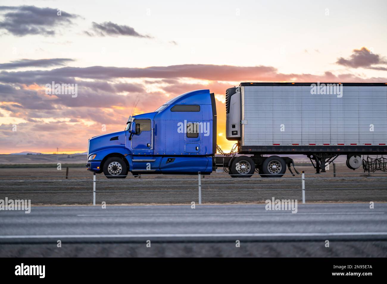 Industrial Long hauler big rig blue semi truck tractor with extended ...
