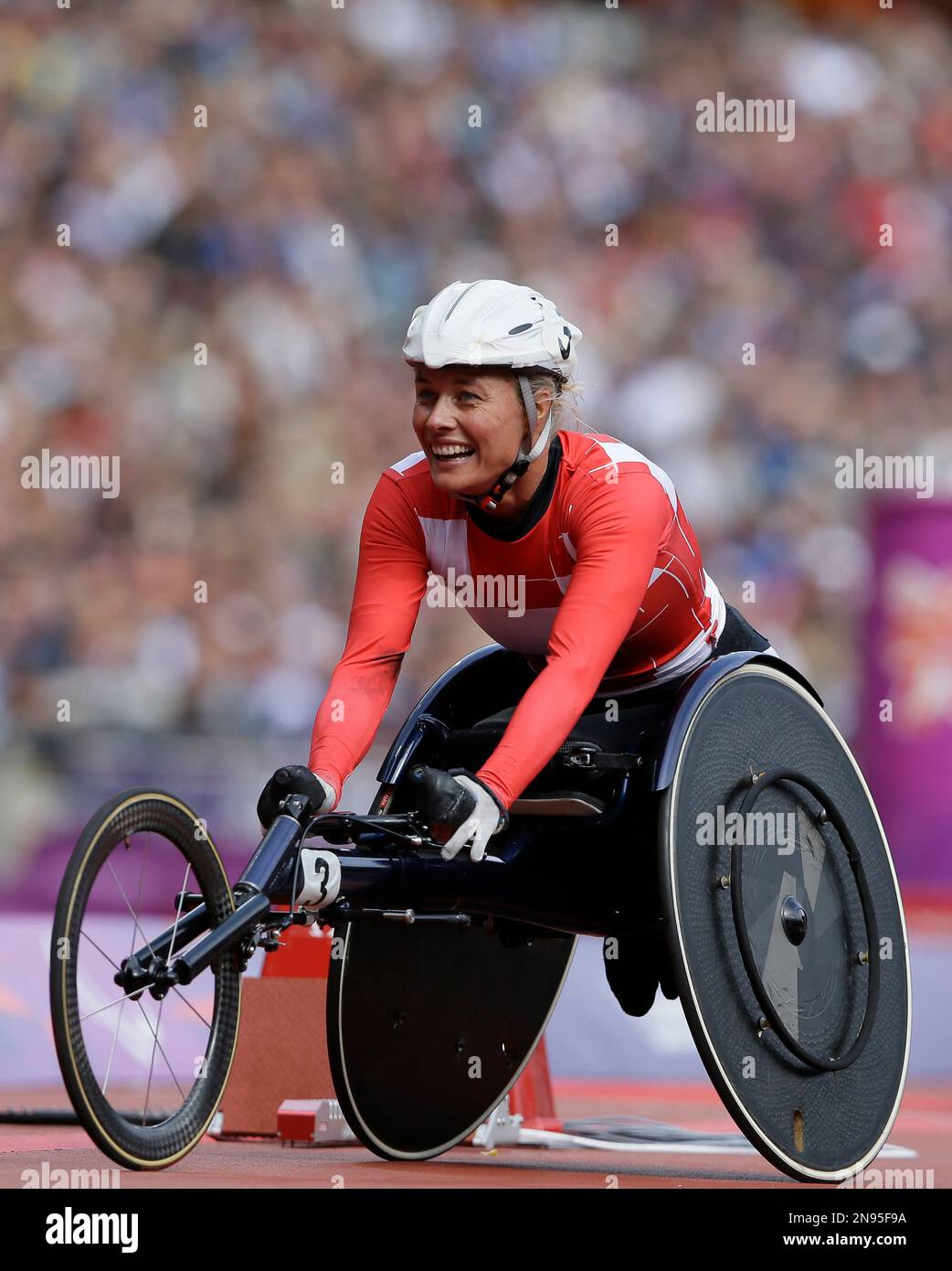 Switzerland's Edith Wolf celebrates winning the women's 5000m T54 race ...