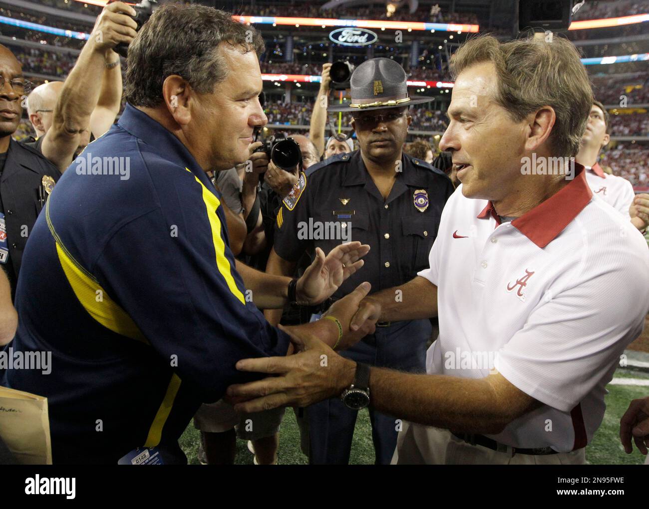Michigan head coach Brady Hoke, left, and Alabama head coach Nick Saban ...
