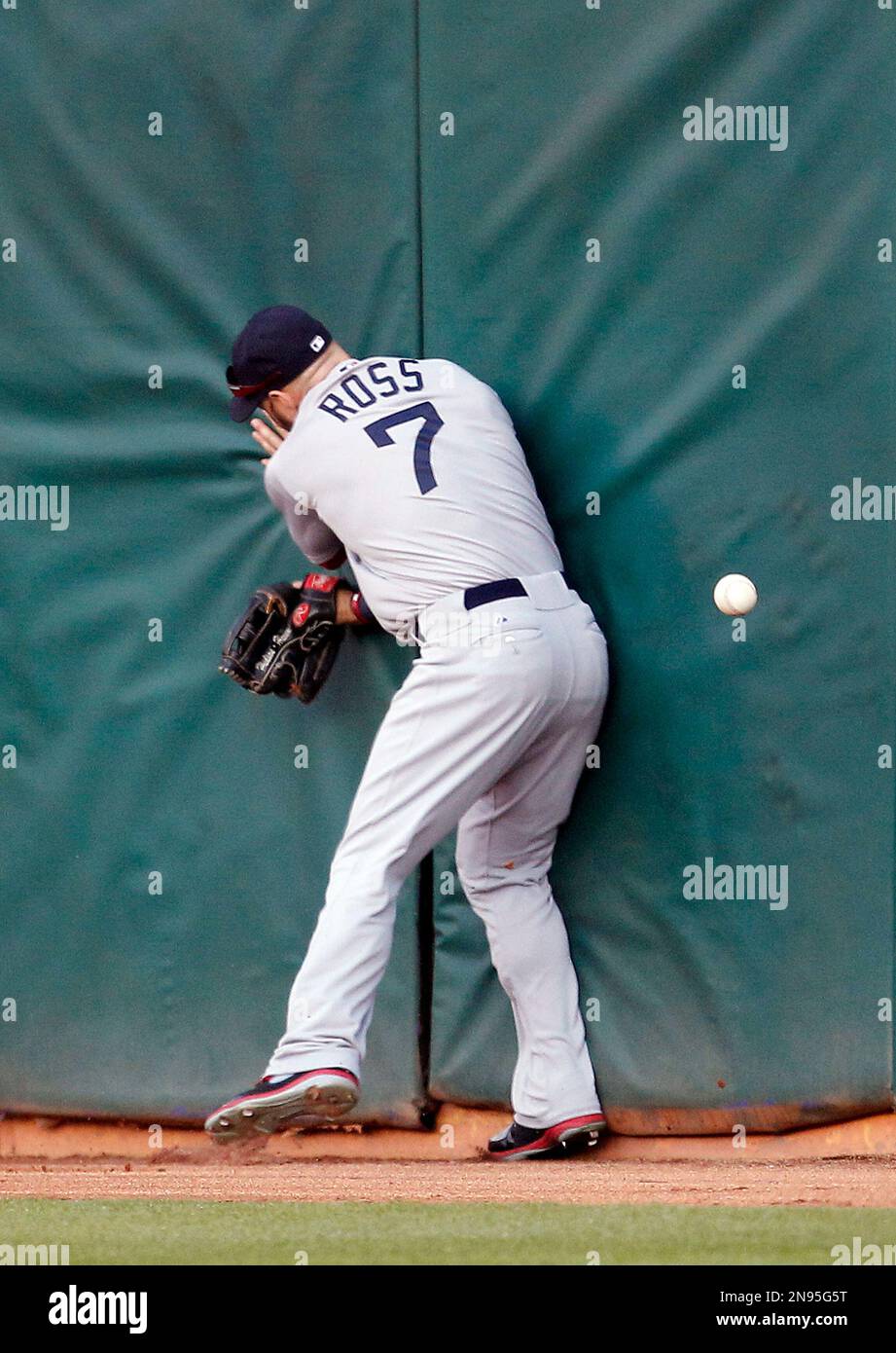 Boston Red Sox right fielder Cody Ross (7) drops the ball as he crashes ...