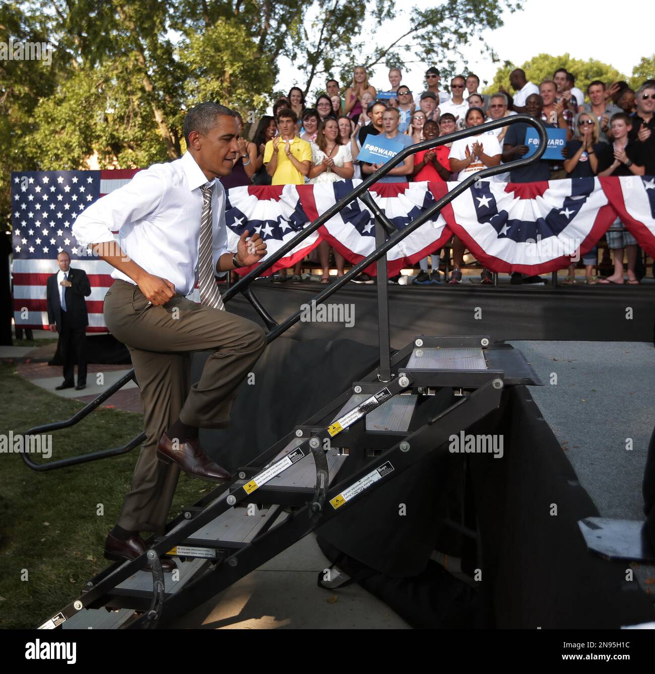 President Barack Obama runs up the stairs before speaking at a campaign ...