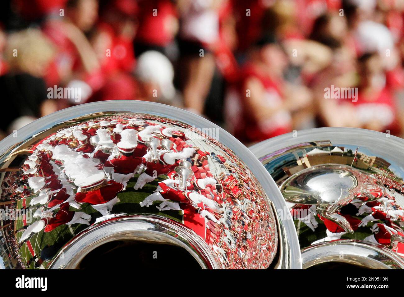The Arkansas marching band is reflected in tuba bells before an NCAA ...