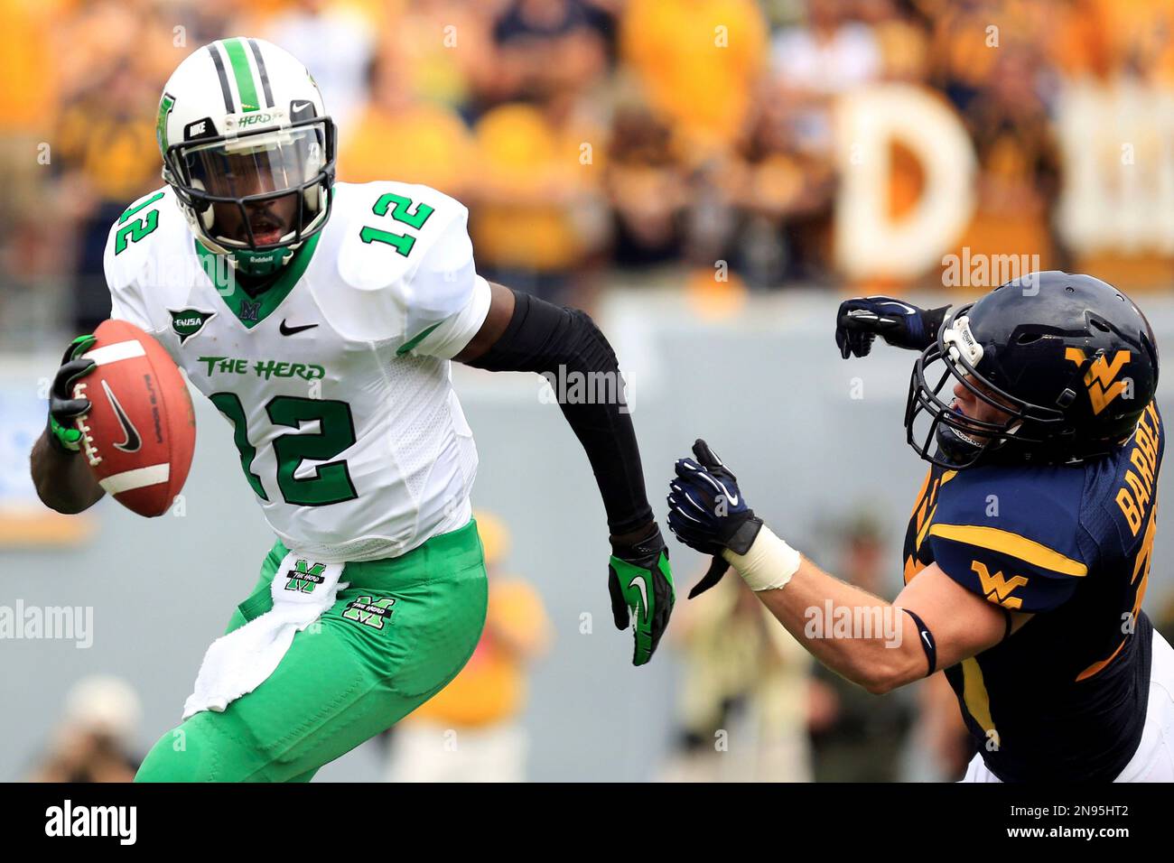 Marshall quarterback Rakeem Cato (12) avoids a sack by West Virginia's ...