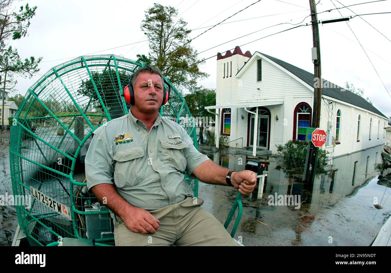 Airport operator Louis Dufrene pilots his craft through flooded streets ...