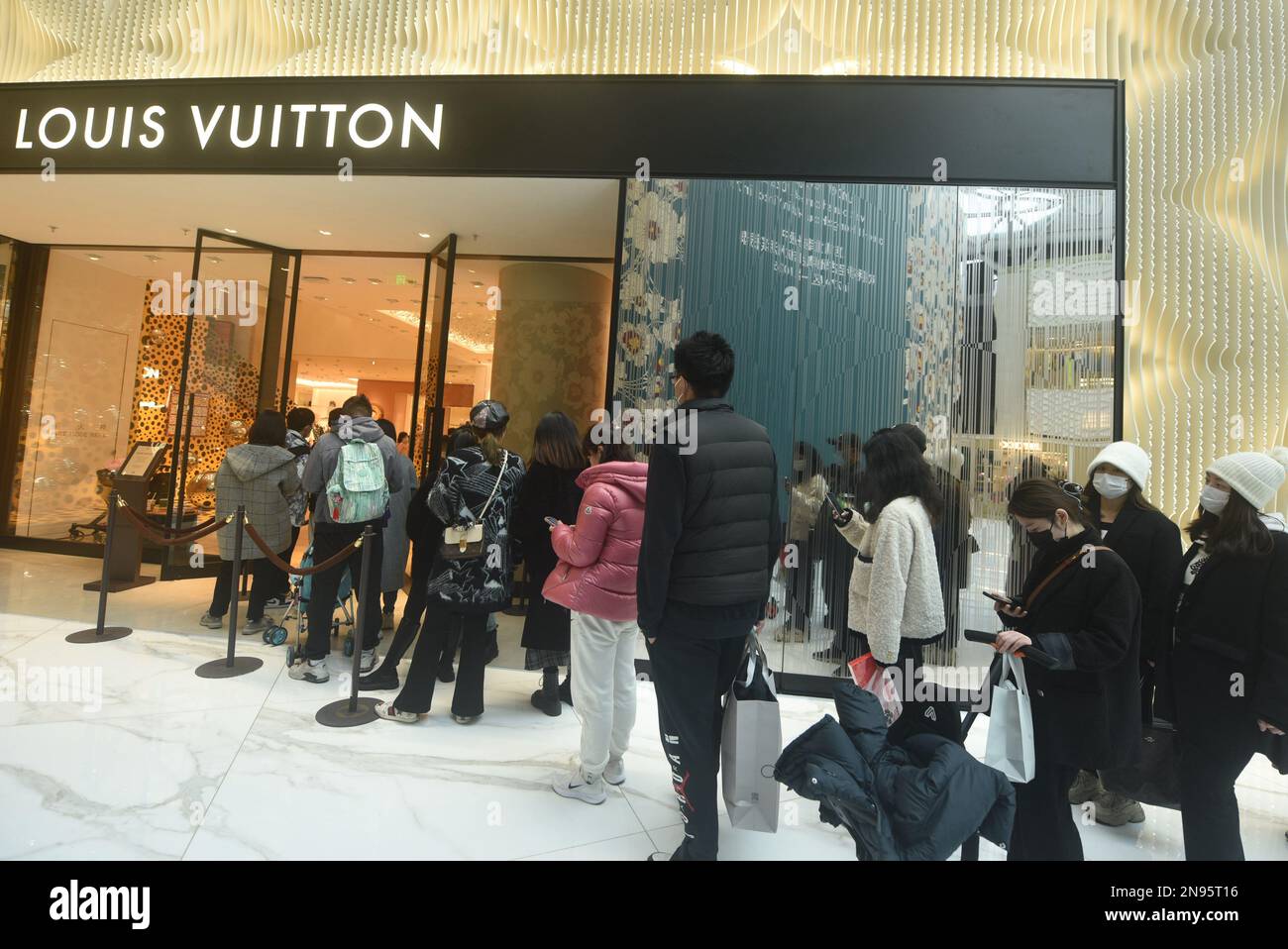 HANGZHOU, CHINA - FEBRUARY 12, 2023 - Customers queue in front of a ...