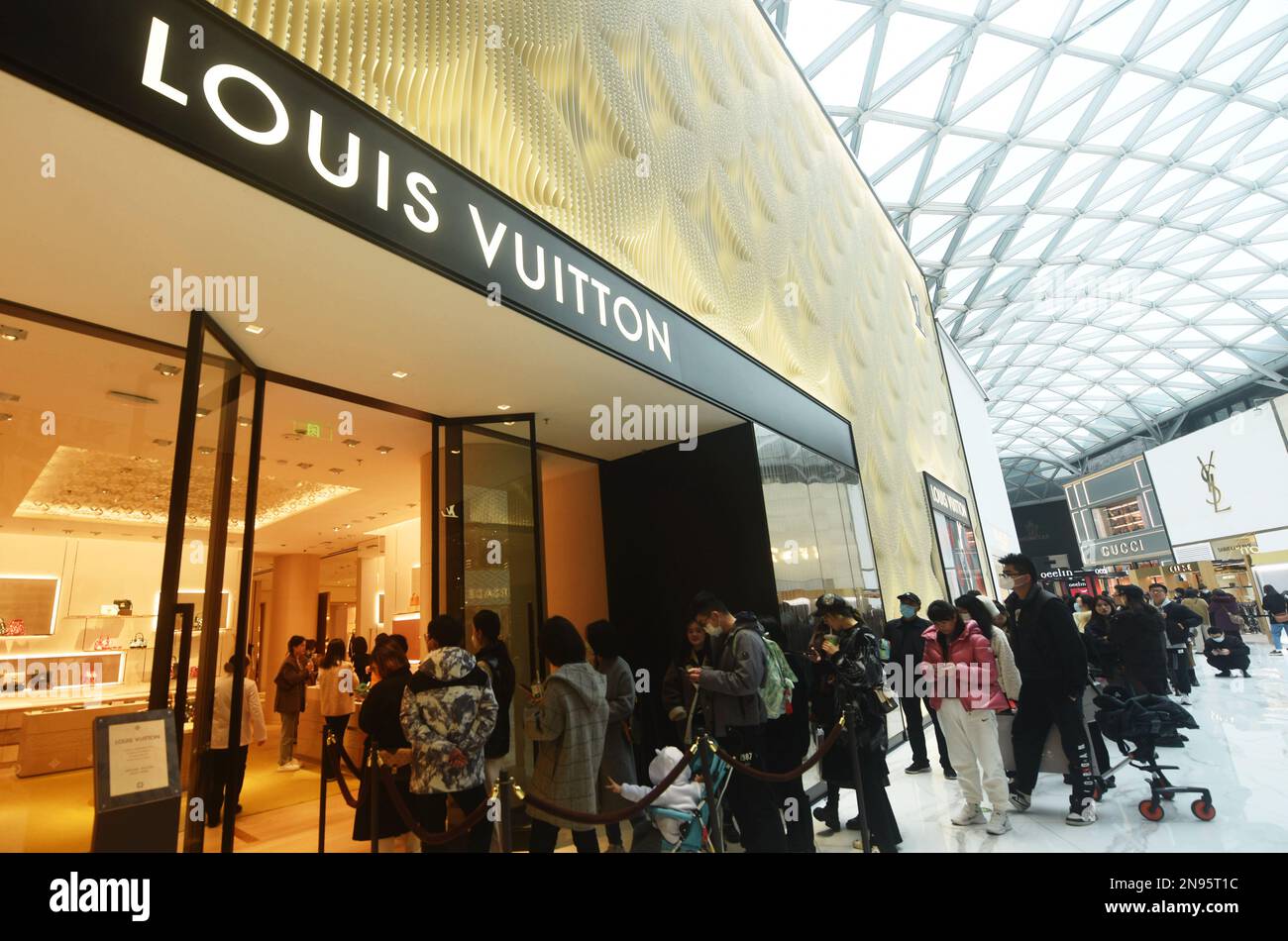HANGZHOU, CHINA - FEBRUARY 12, 2023 - Customers queue in front of a ...