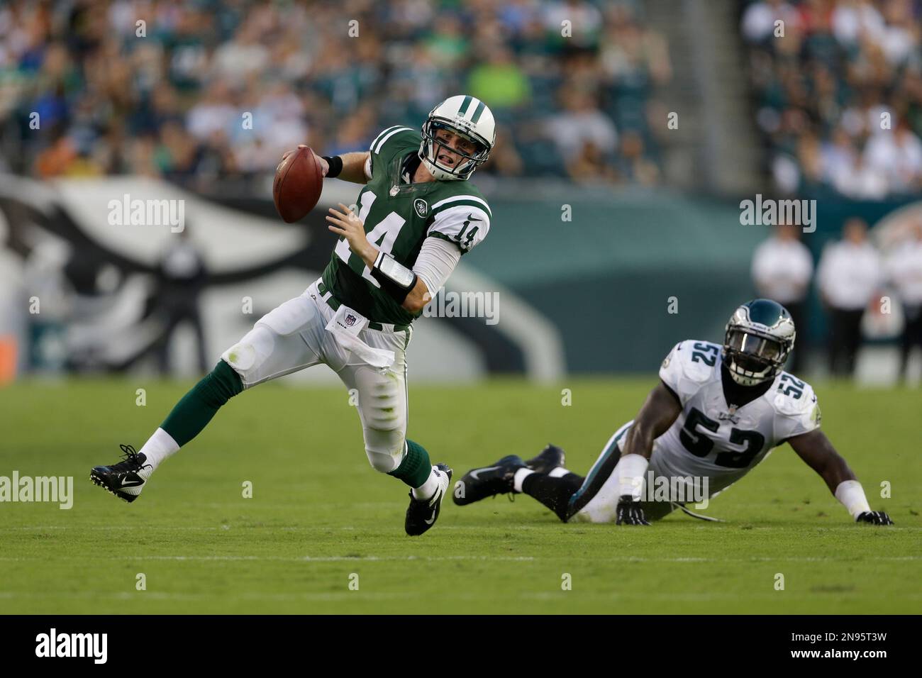 New York Jets quarterback Greg McElroy, left, scrambles away from ...