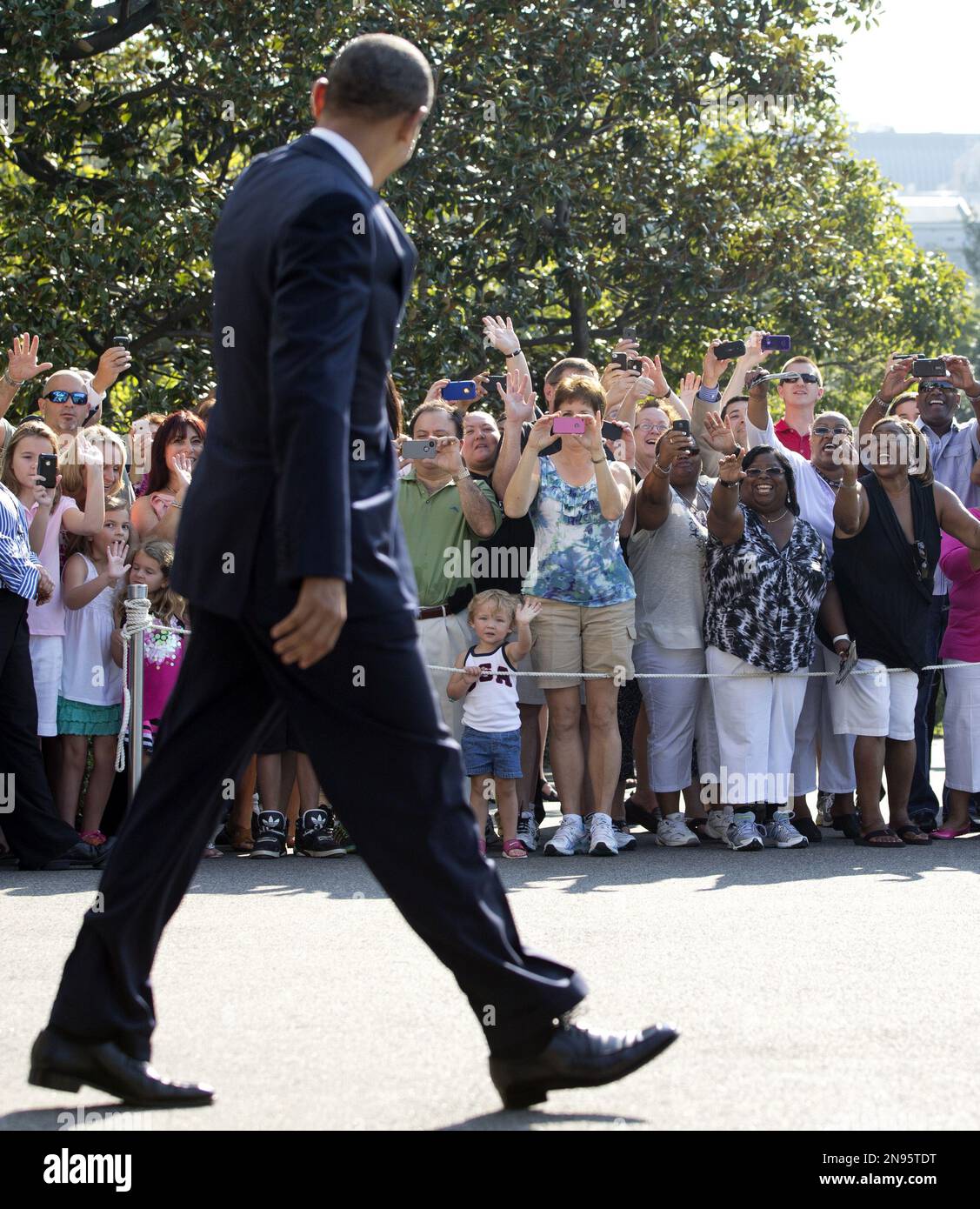 President Barack Obama waves to a crowd as he walks from the White ...