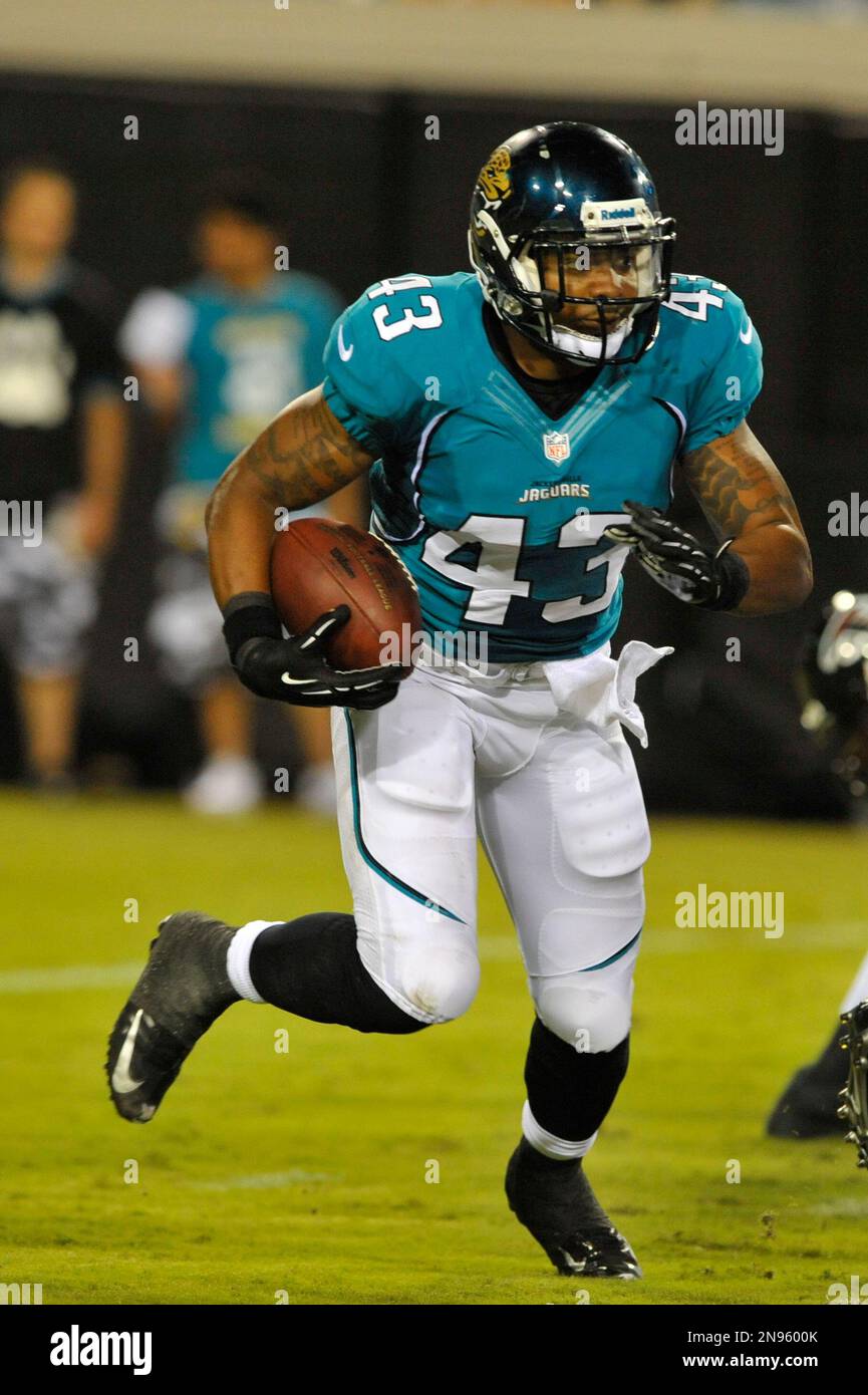 Jacksonville Jaguars running back Keith Toston gains yardage against ...