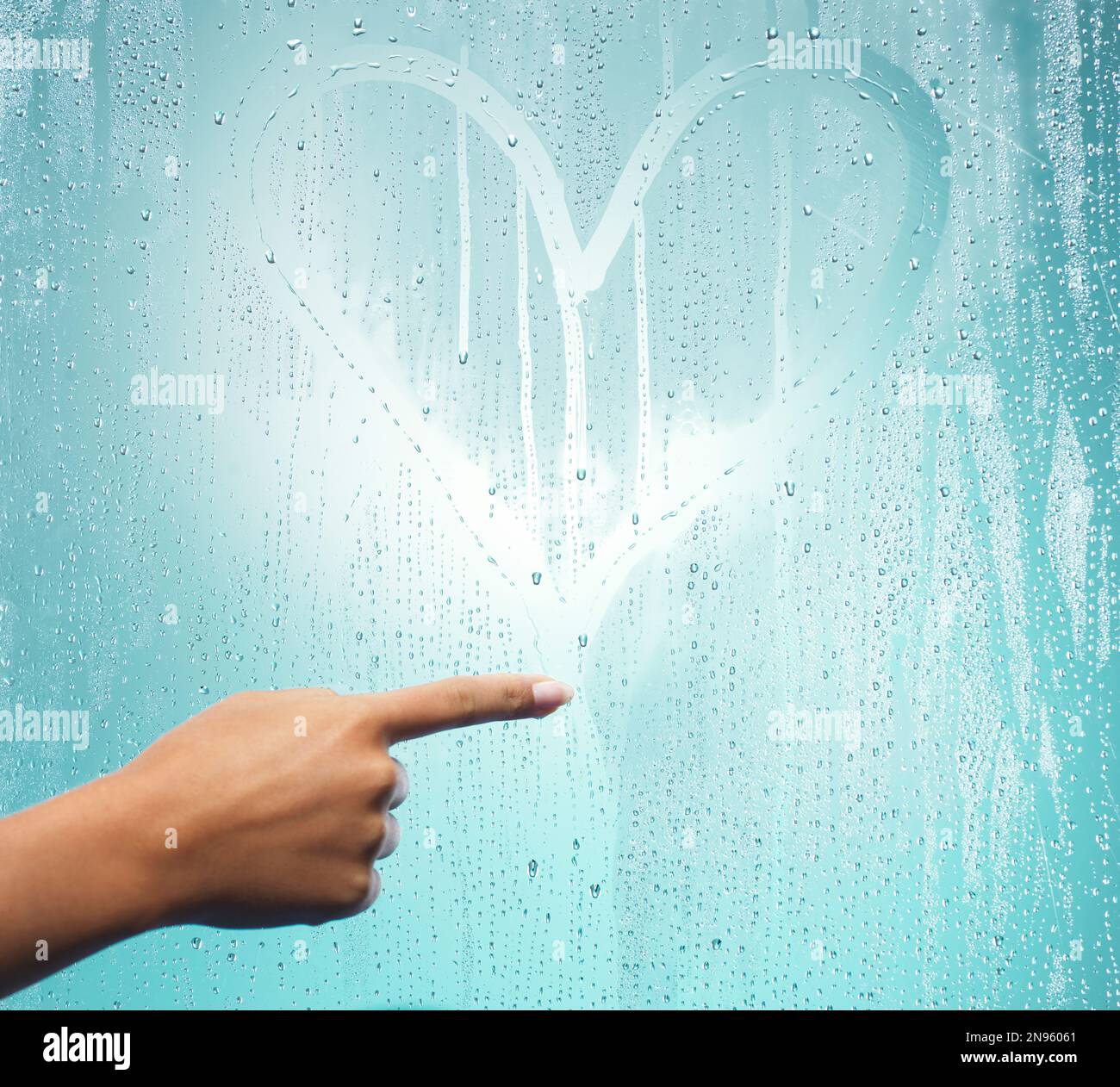 Little message for you. a heart on a glass surface against a blue ...