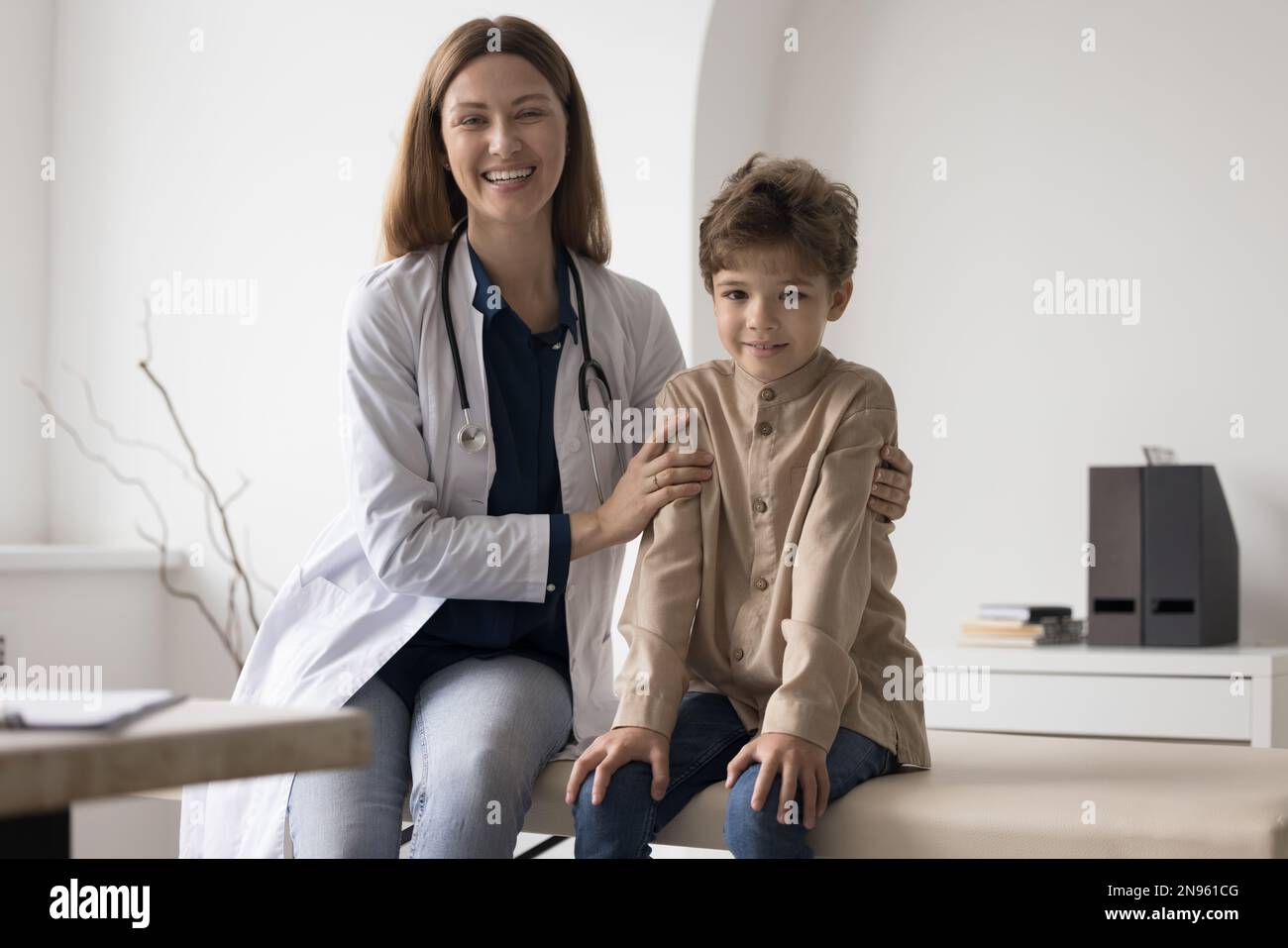 Happy pediatrician woman and patient boy portrait Stock Photo - Alamy
