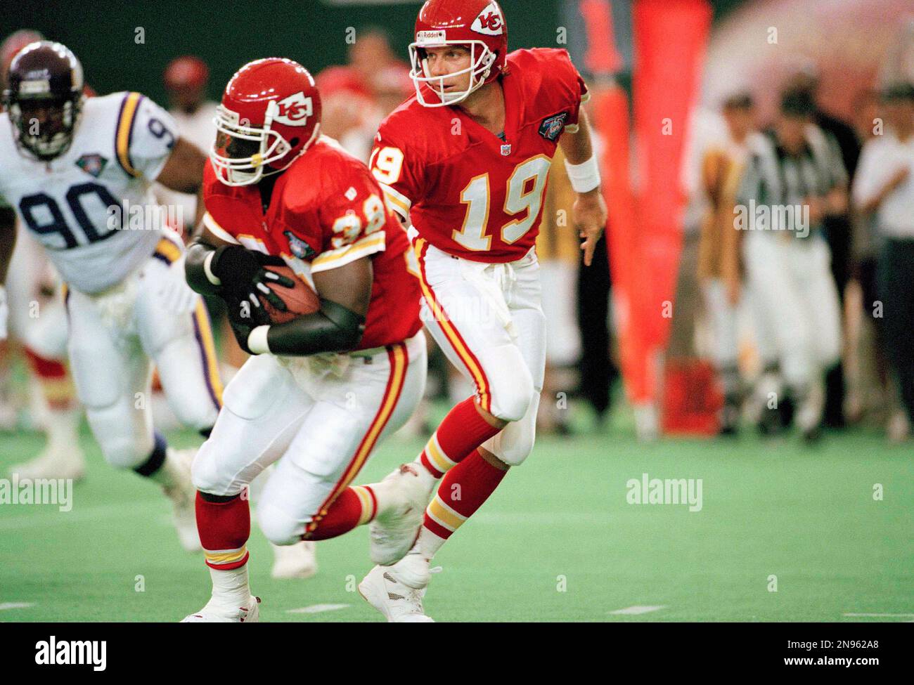 Kansas City Chiefs quarterback Joe Montana (19) looks at his teammate ...