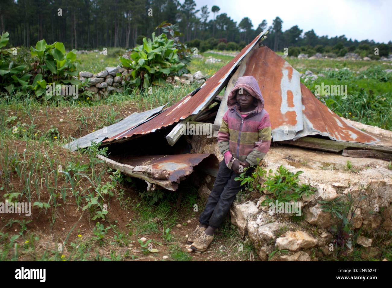 In this picture taken Aug. 16, 2012, a boy leans against the base of an ...