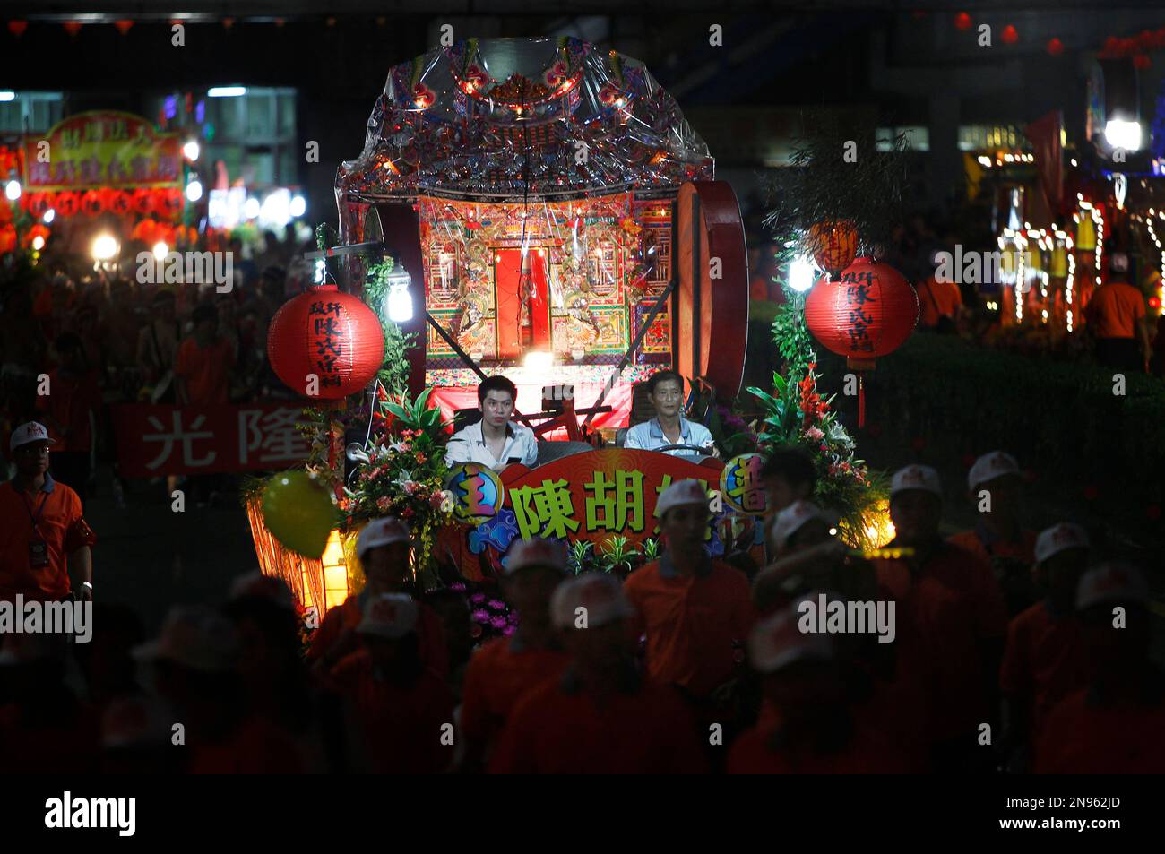 Celebrating the mid-summer Chinese Ghost Month Festival, two devotees ...