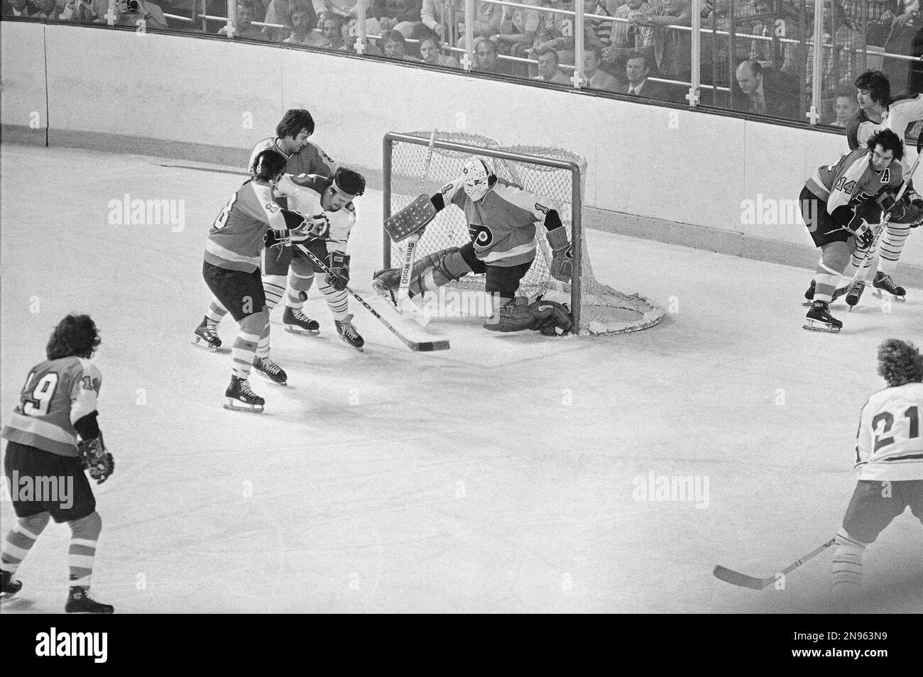 The puck hangs in the air between Philadelphia Flyers Ross Lonsberry ...