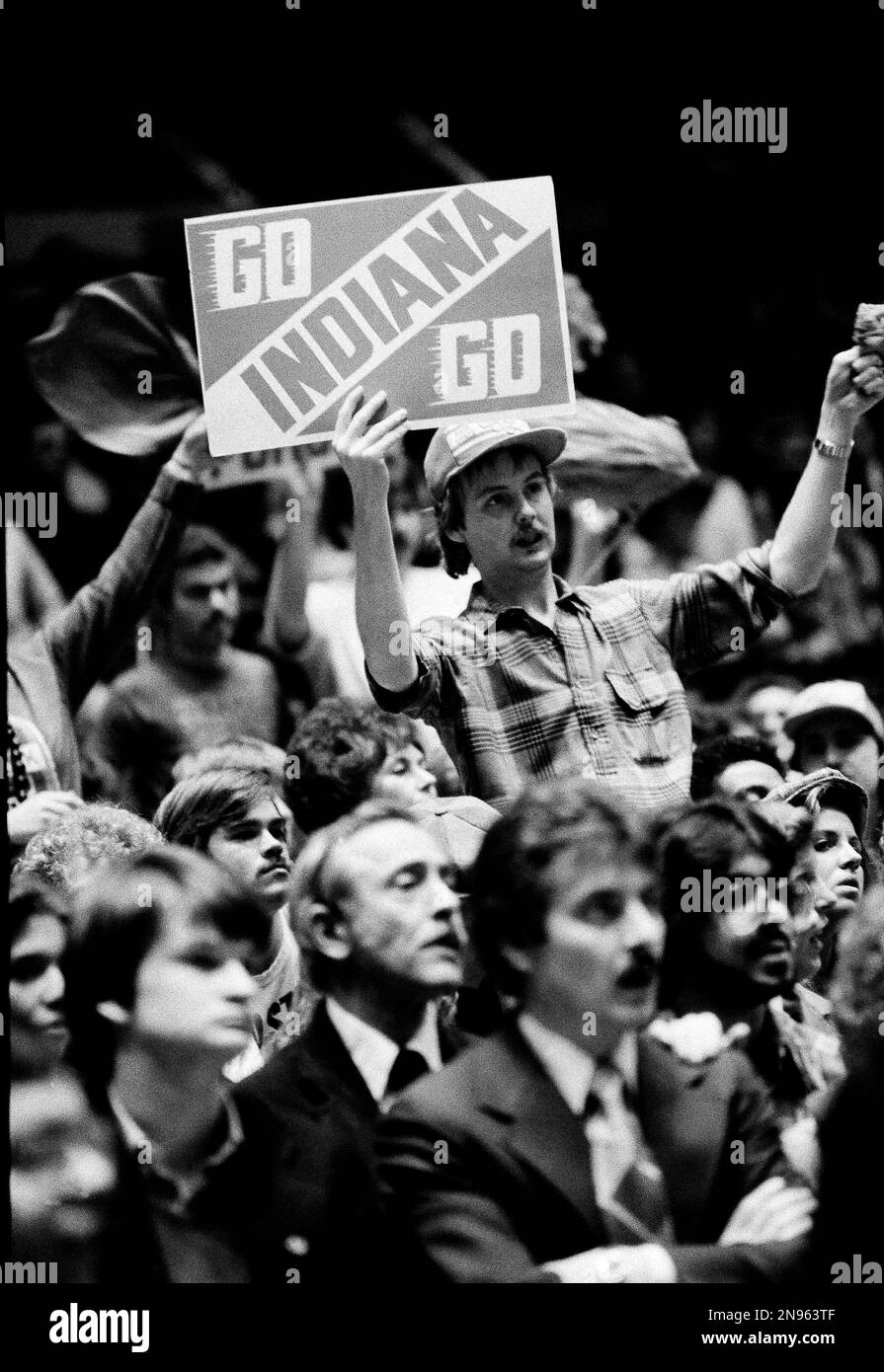 A fan waves a "Go Indiana Go" sign as the Indiana team battles Purdue ...
