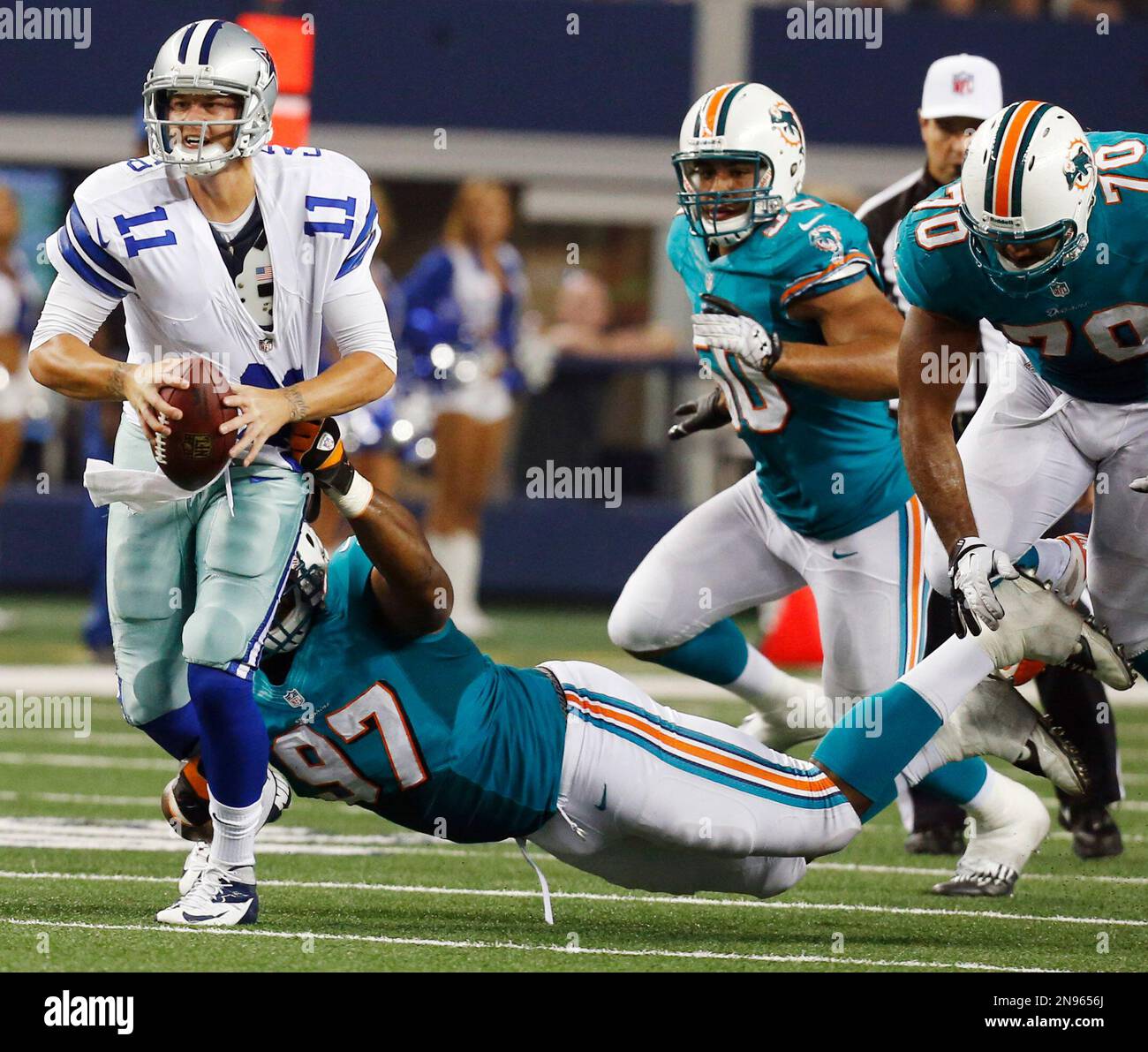 Dallas Cowboys quarterback Rudy Carpenter (11) is tackled by Miami ...