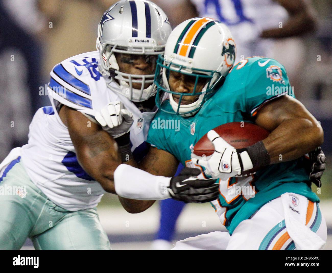 Dallas Cowboys' Eddie Whitley, left, tackles Miami Dolphins running ...