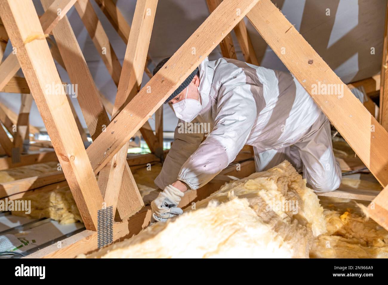 thermal insulation of roof spaces with glass wool Stock Photo - Alamy