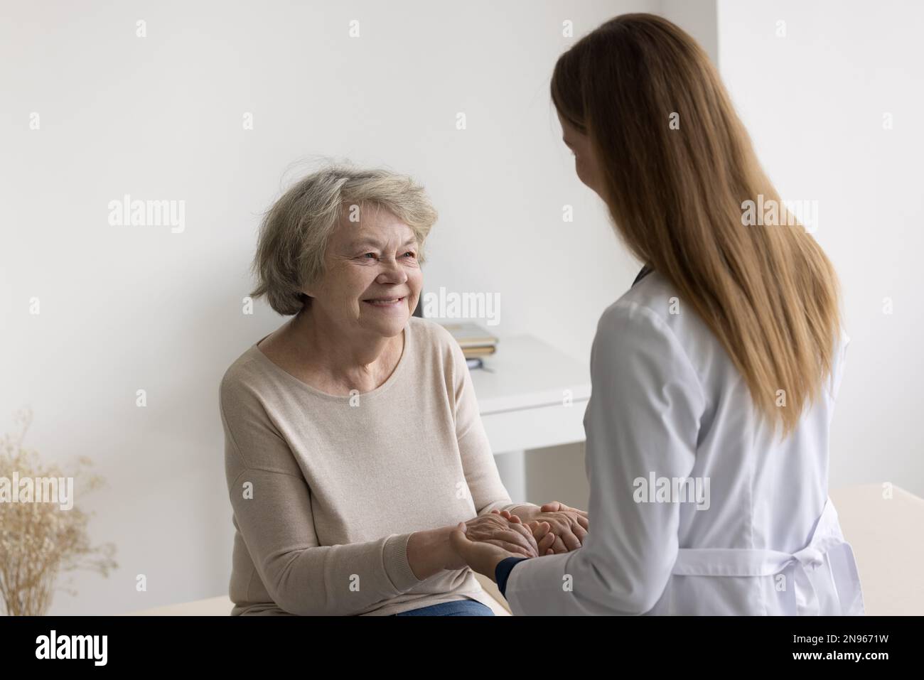 Cheerful elderly 80s patient woman visiting empathetic doctor Stock ...