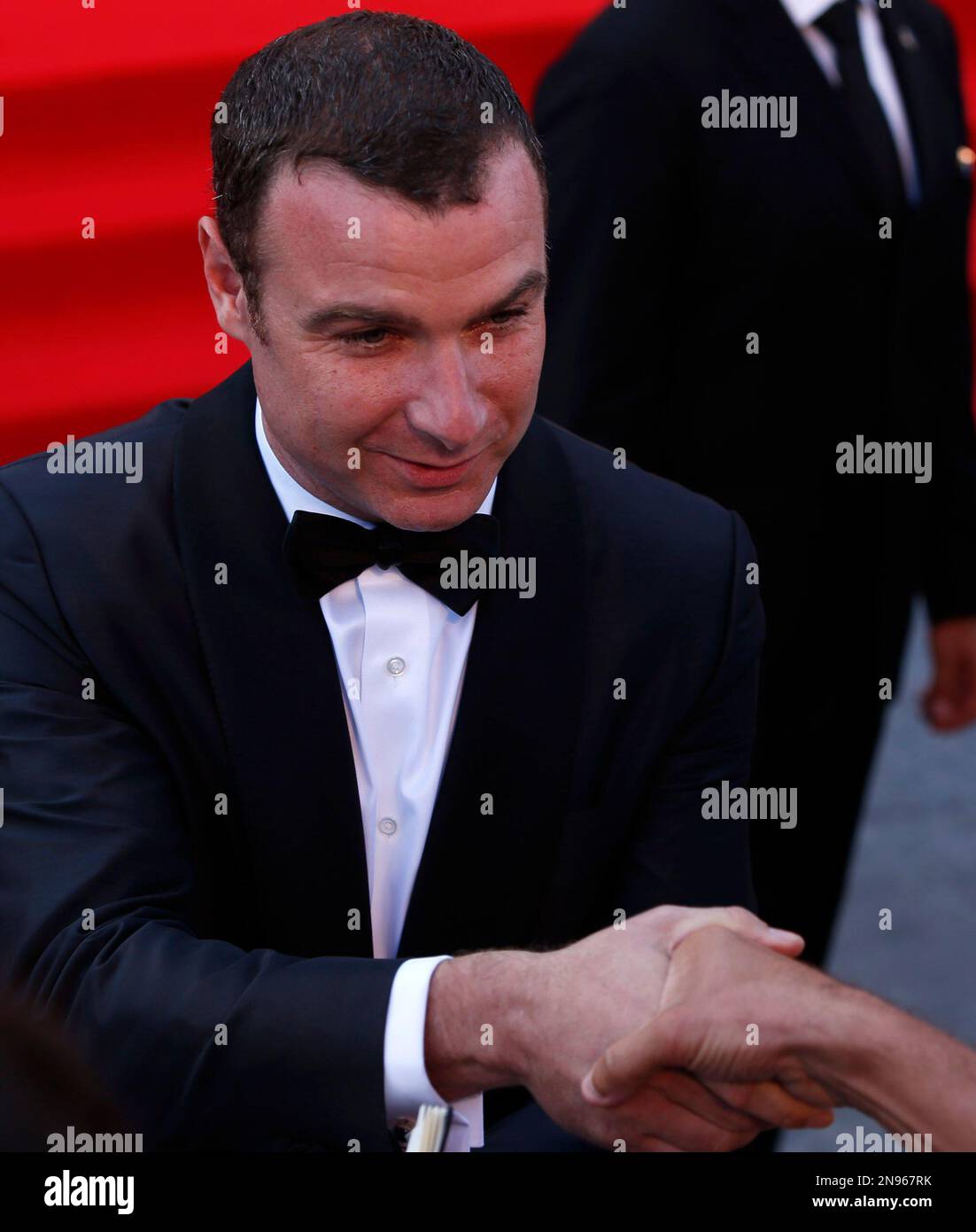 Actor Liev Schreiber greets a fan as he arrives on the red carpet for ...