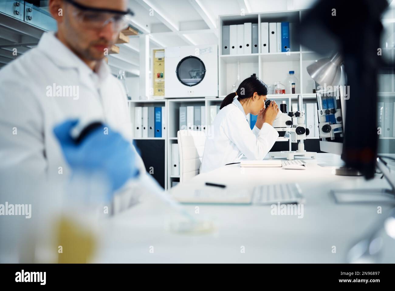 The lab is a beehive for big change. a young scientist using a ...