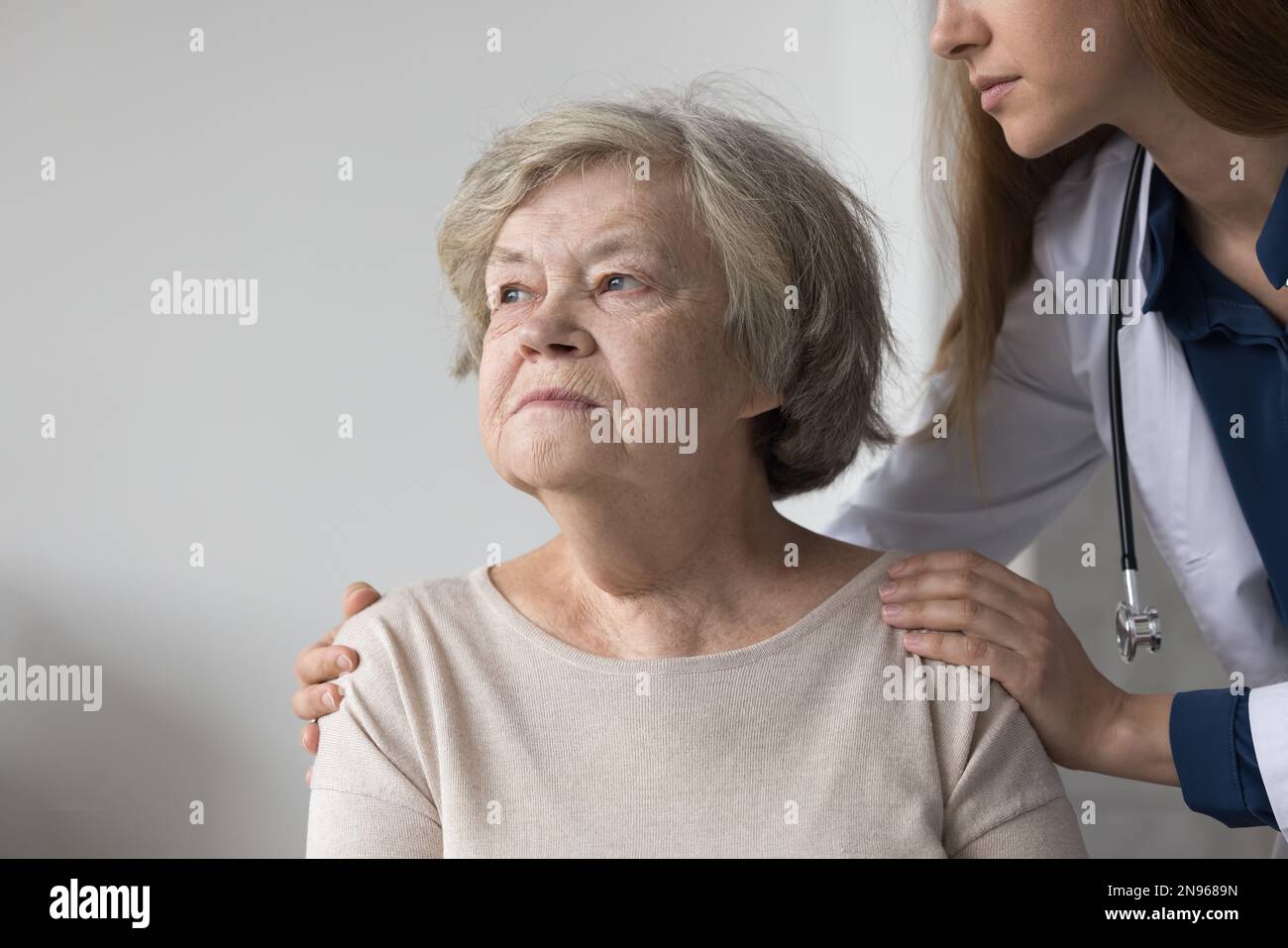 Thoughtful sad older patient woman sitting near doctor Stock Photo - Alamy