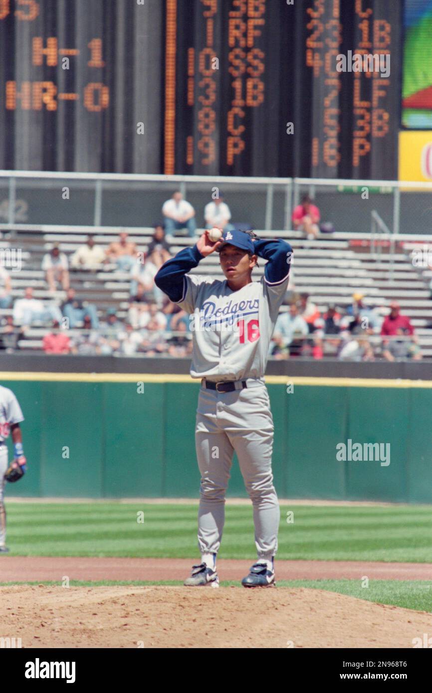 Los Angeles Dodgers pitcher Hideo Nomo adjusts his cap during a game ...