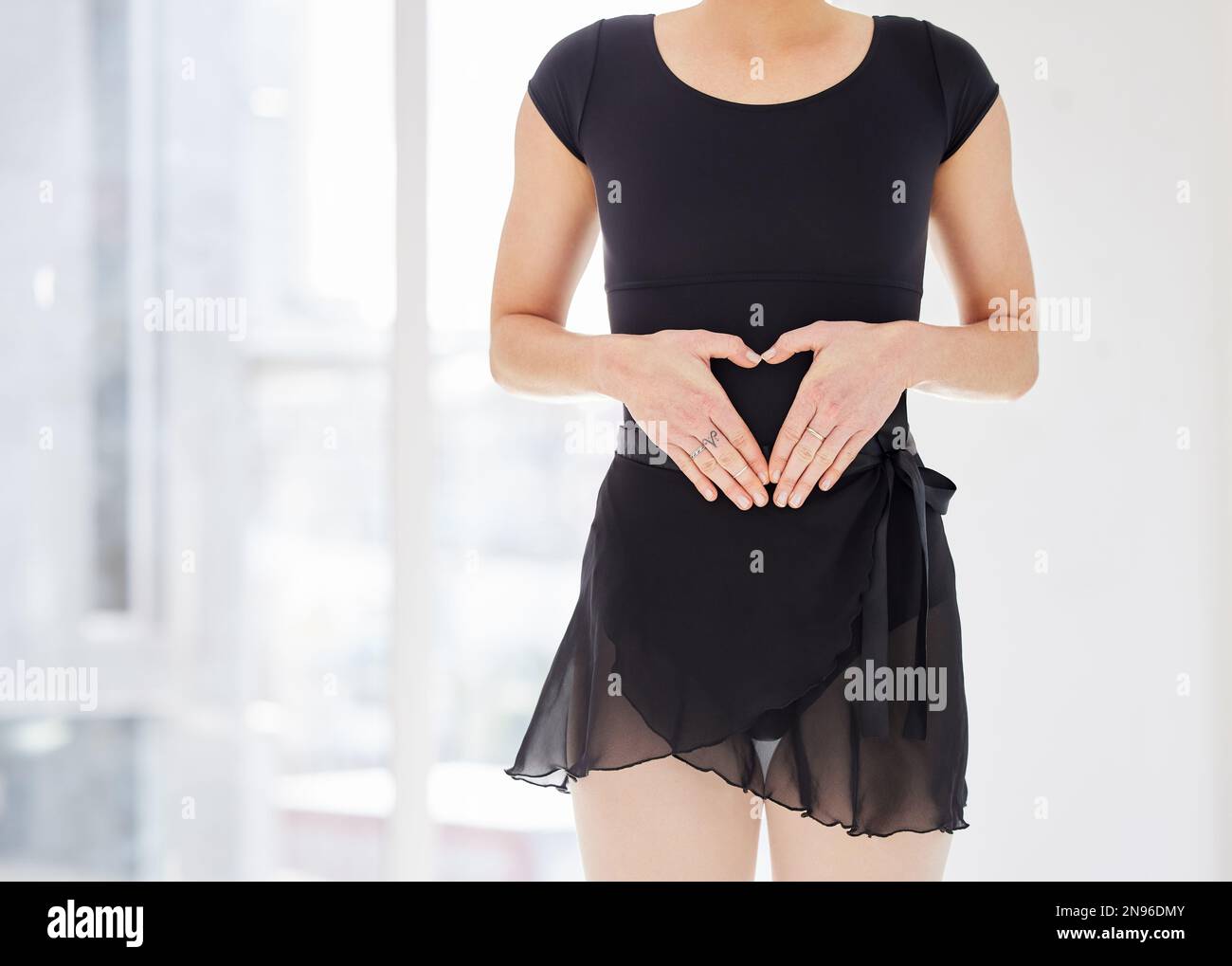 A strong body makes a strong dancer. a ballerina creating a heart shape ...