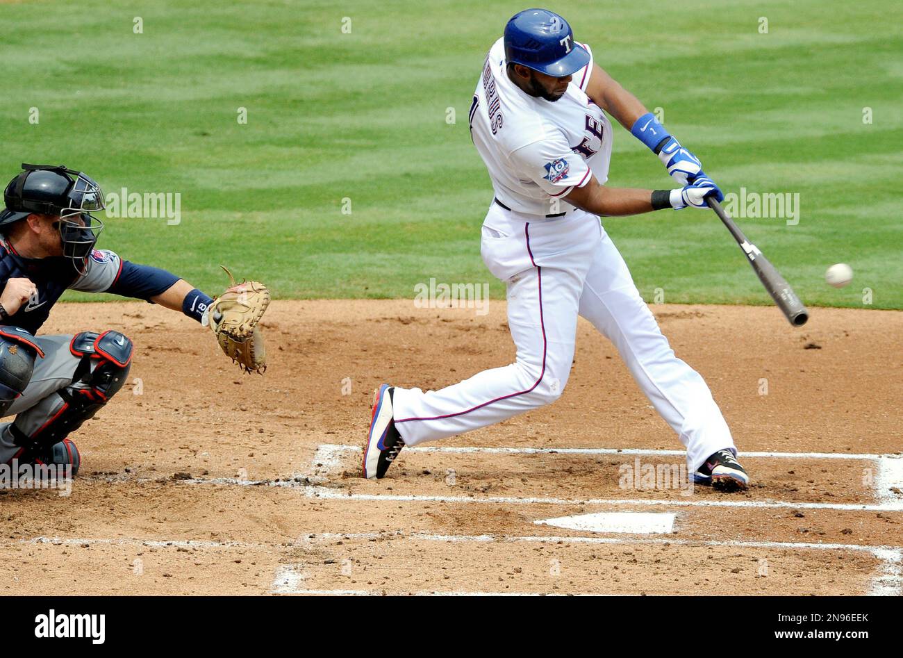 Texas Rangers Elvis Andrus, right, swings at a pitch in front of ...