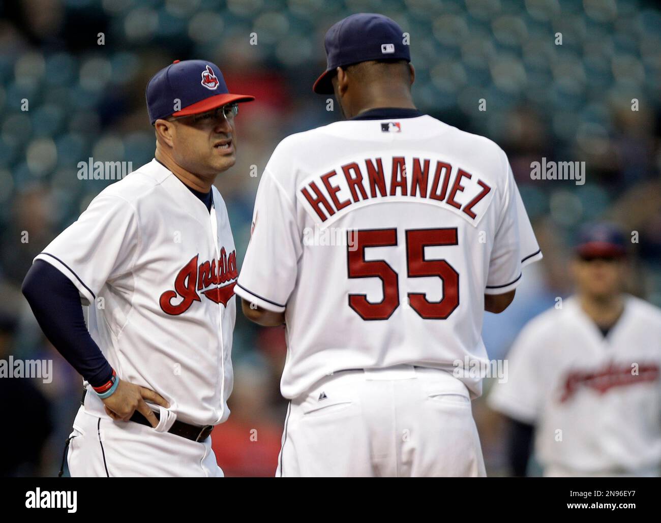 Cleveland Indians manager Manny Acta, left, check on starting pitcher ...