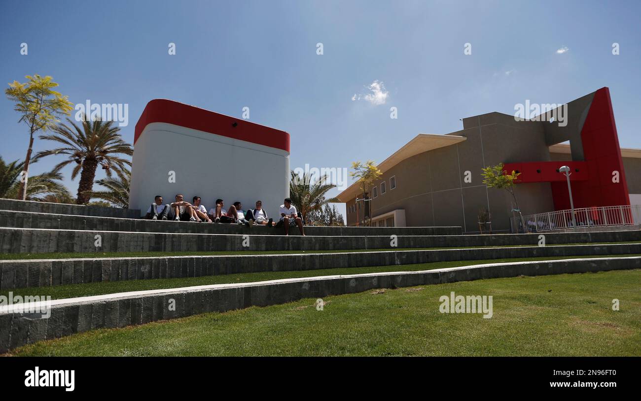 Israeli high-school students sit in the shade provided by a fortified ...