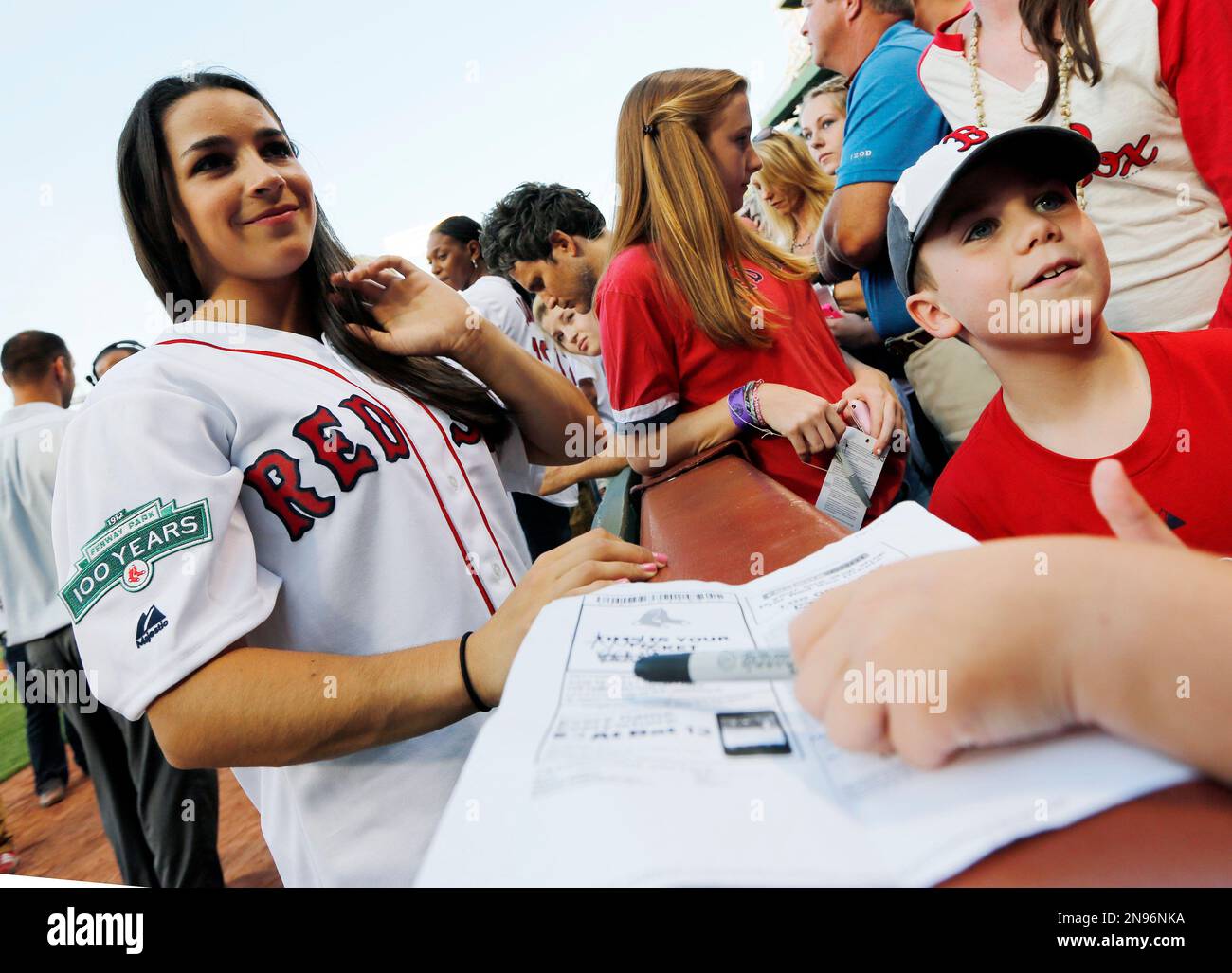 Olympic gold medalist in gymnastics Aly Raisman, left, signs autographs ...