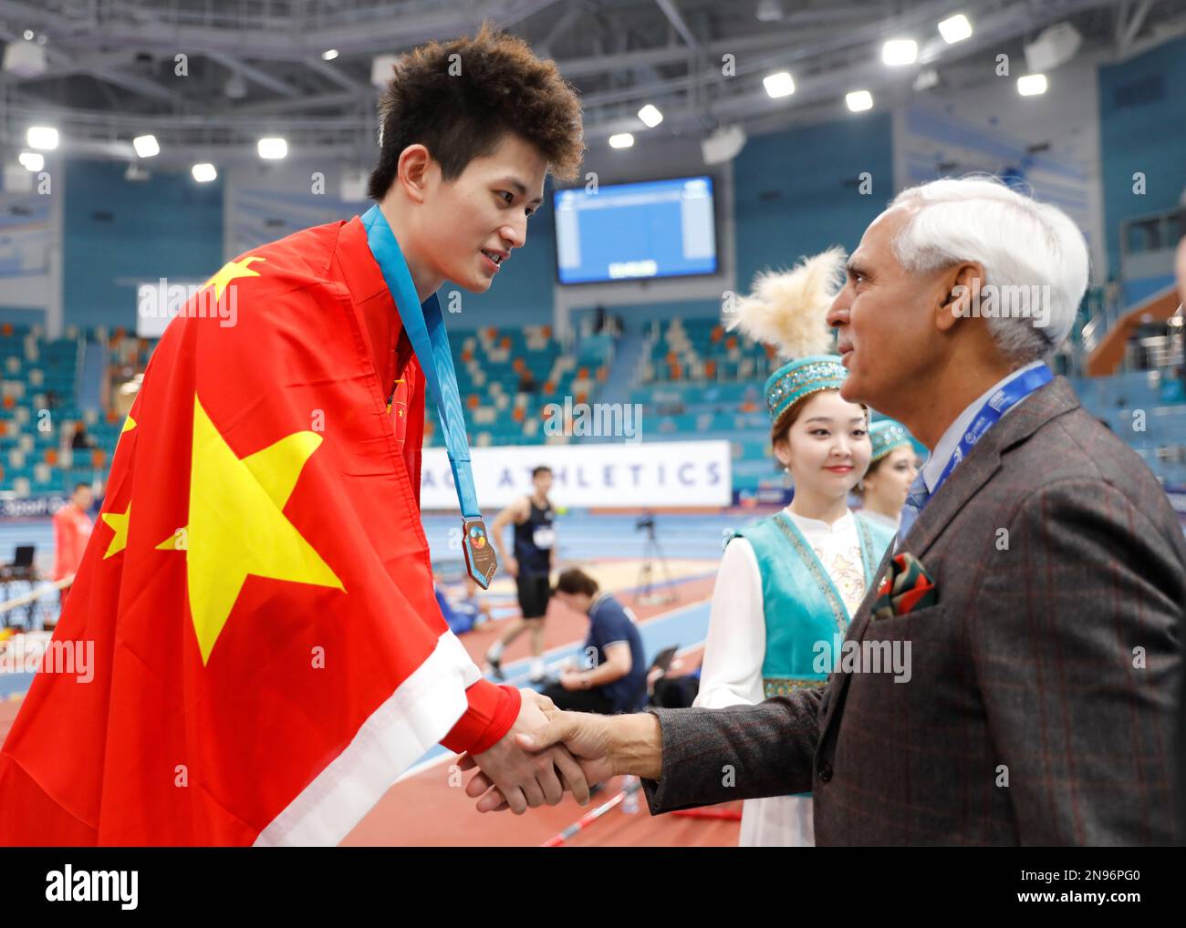 Astana, Kazakhstan. 12th Feb, 2023. Bronze medalist Zhang Mingkun (L) of China gets ...