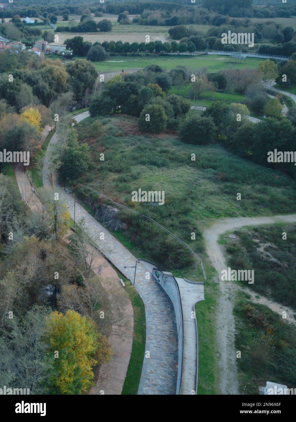 A vertical aerial view of pathways in a green park in the countryside ...