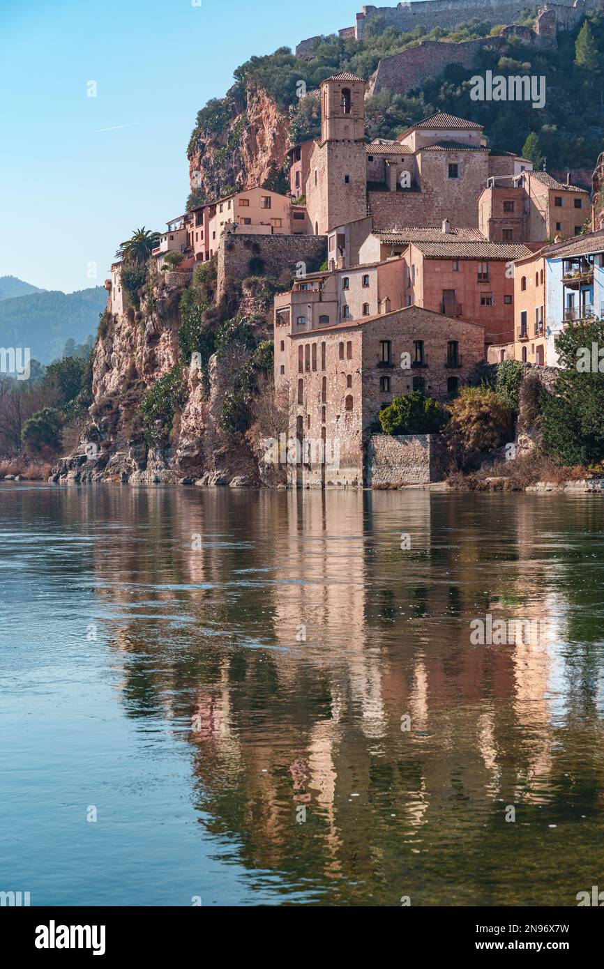 Old town of miravet with the templar castle on the top and the ebro river flowing quietly on a ...