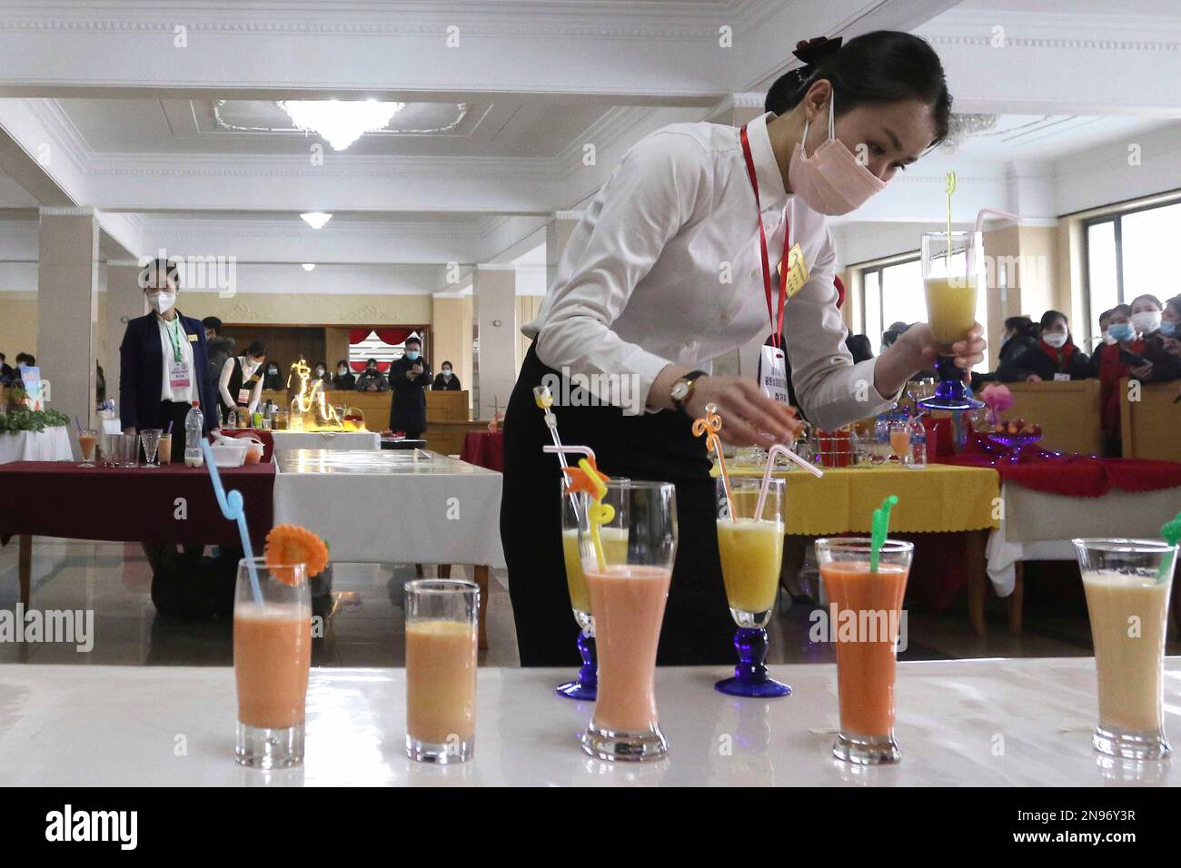 A woman brings a fruit drink for judgement as the National Cooking ...