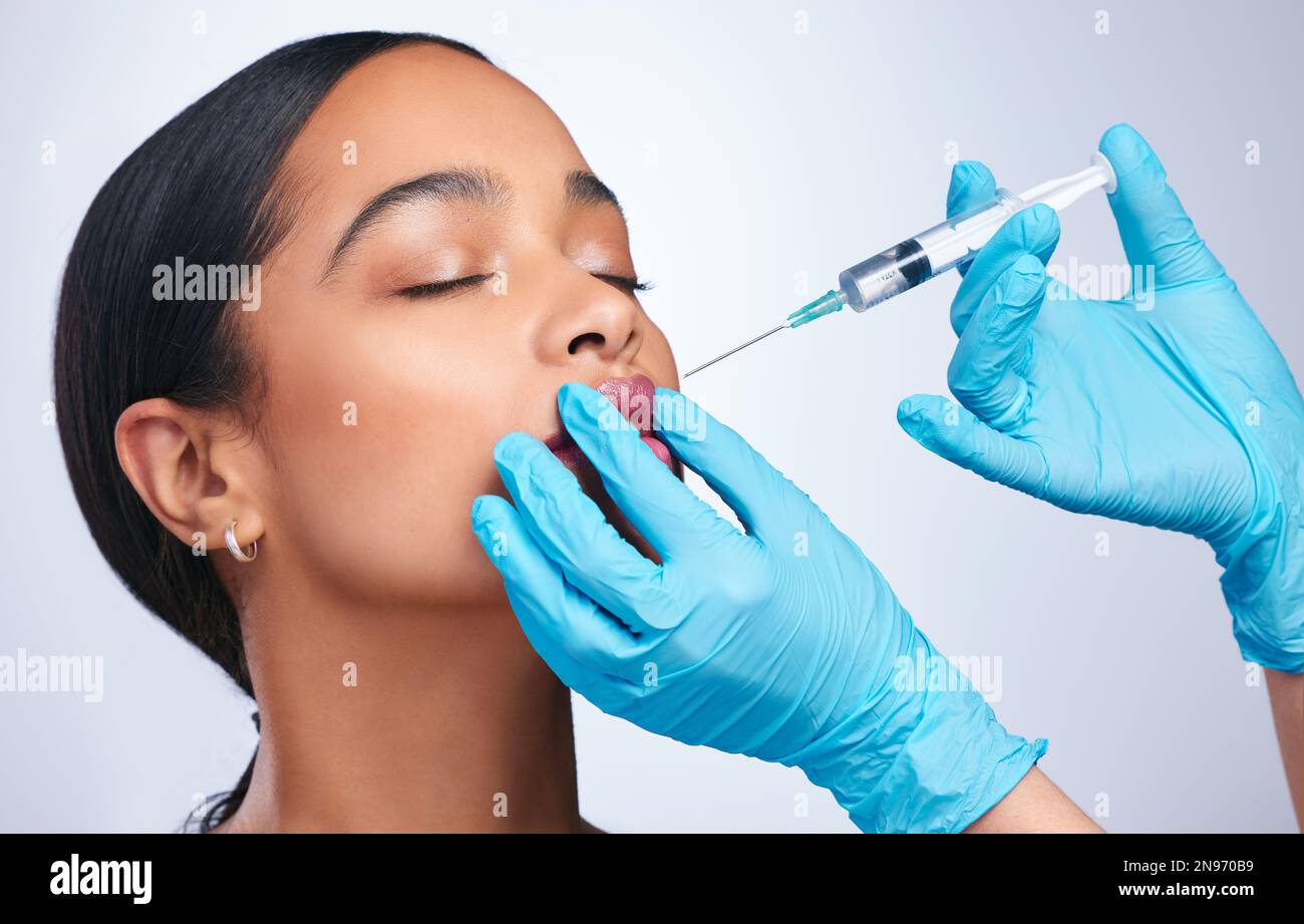 Purchased smiles. a beautiful young woman having a botox session ...