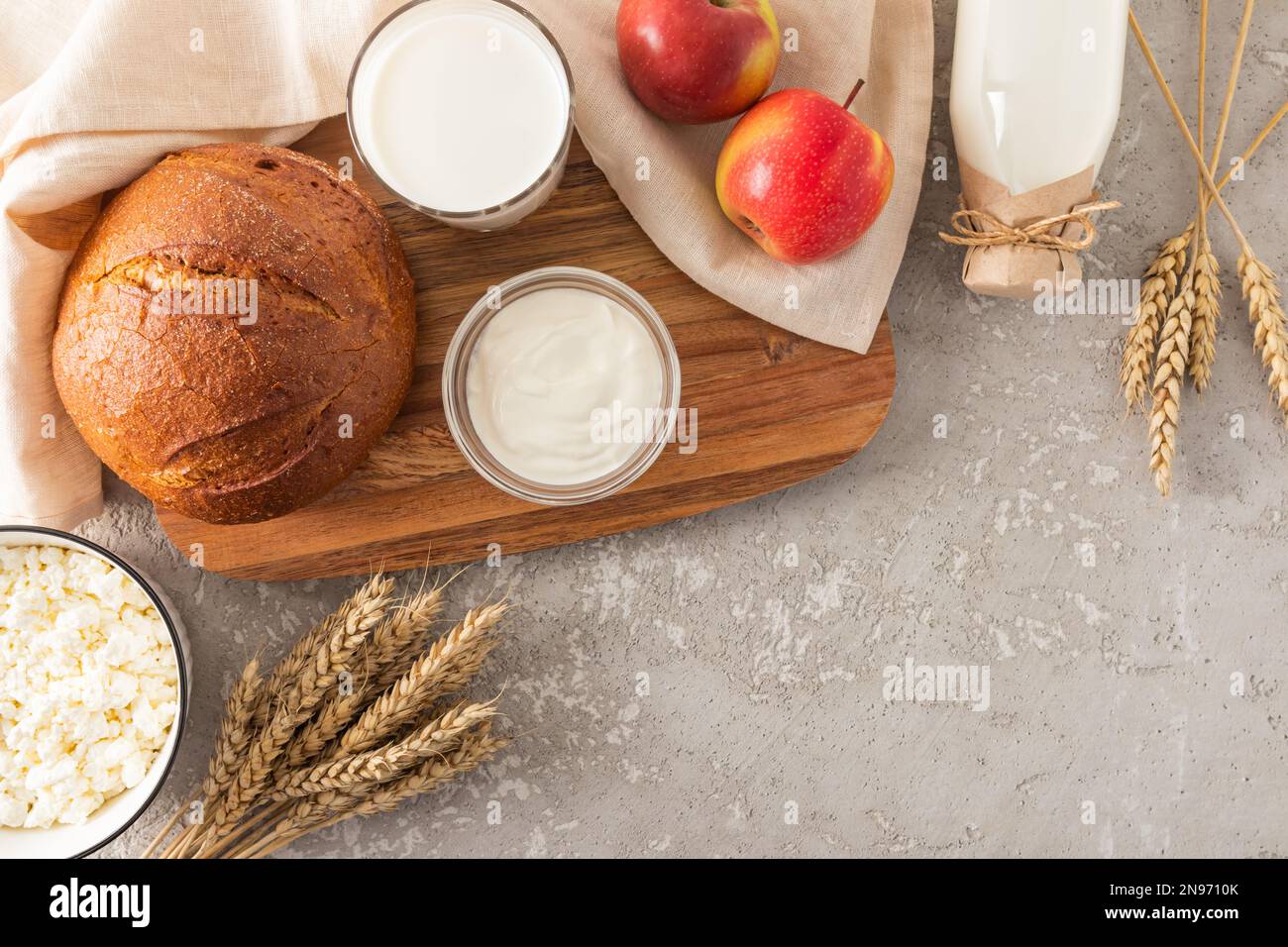 fresh dairy products, a loaf of bread, a bouquet of ears of corn ...