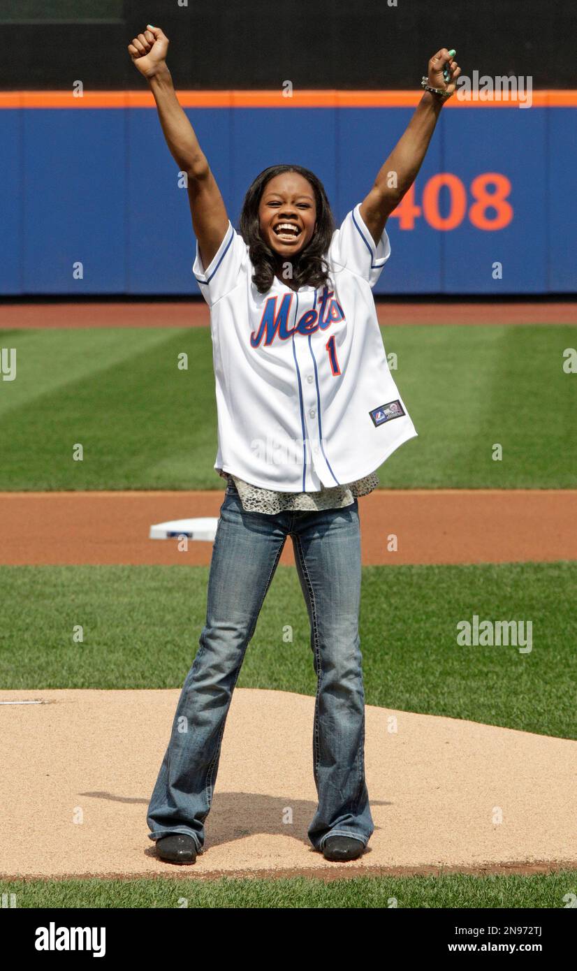 Olympic gold medal gymnast Gabrielle Douglas reacts after throwing the ...