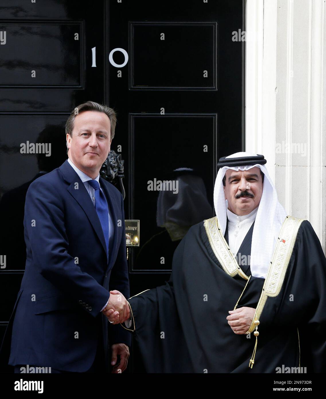 Britain's Prime Minister David Cameron, left, greets King Hamad bin Isa ...