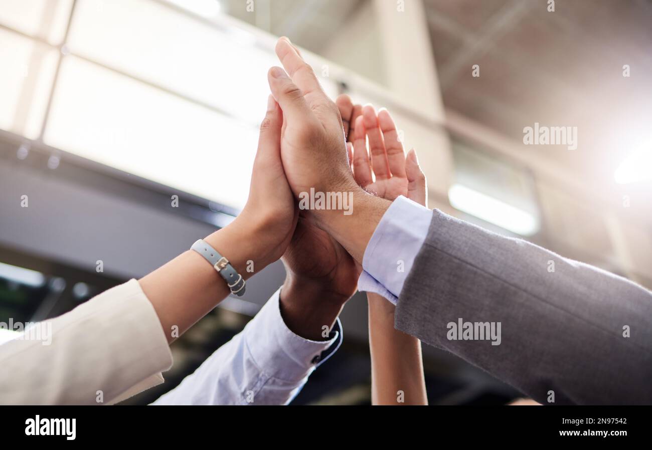 Support your team members. a group of business people high fiving each ...