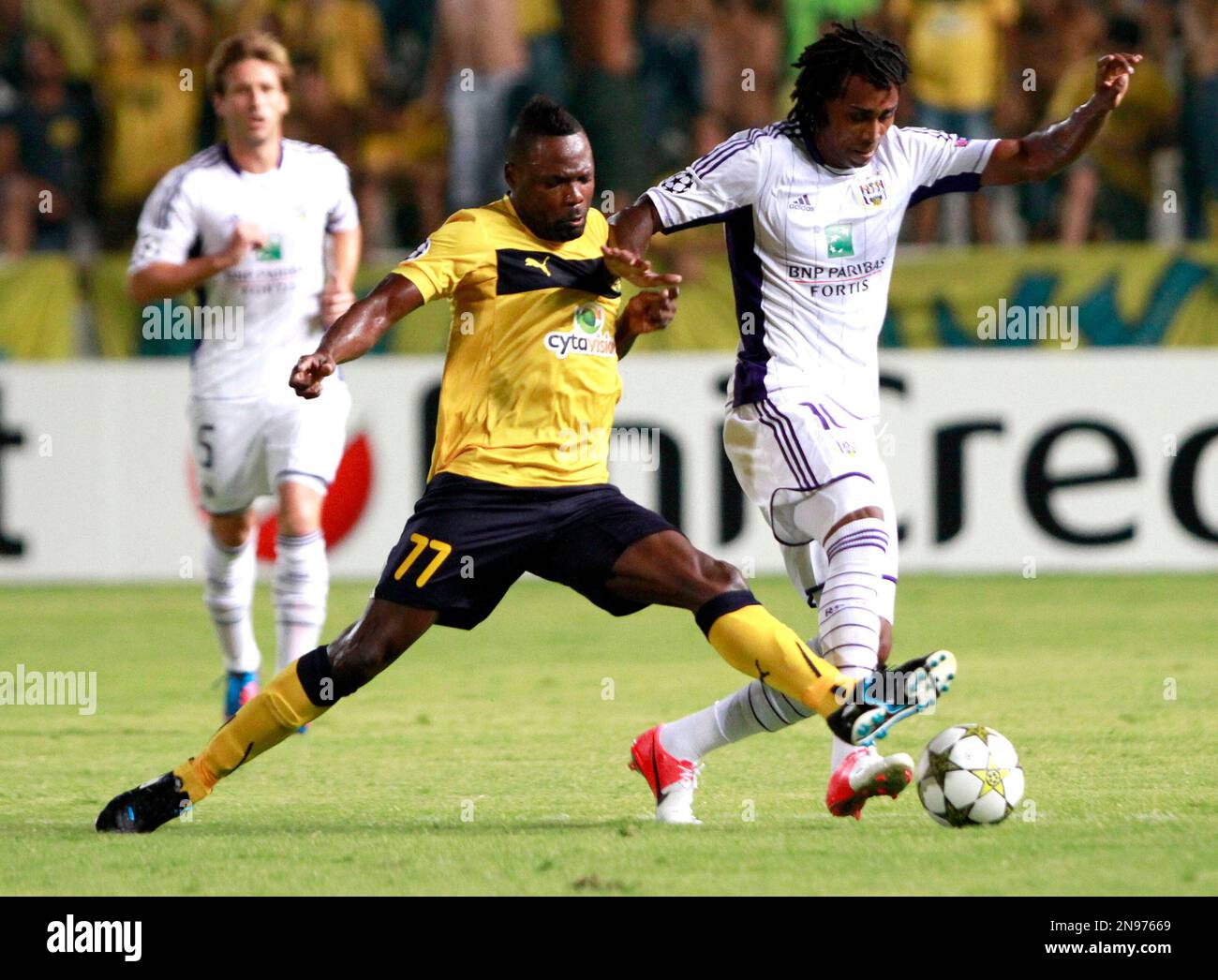 Dede, left, of AEL, Limassol, challenges for the ball with Kenu of ...