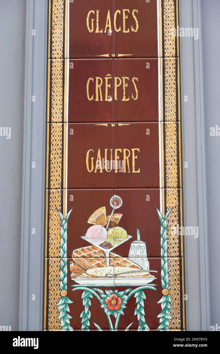 France, Nice, tiled food murial on cafe wall showing Glaces and Crepe’s ...