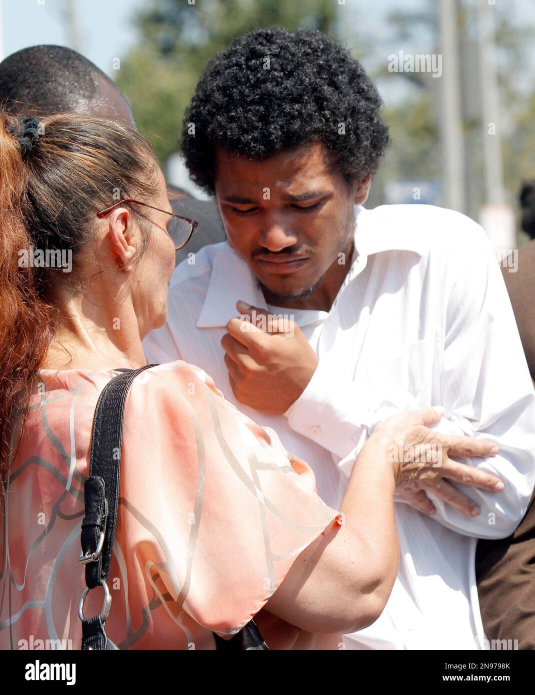 Ronald Weekley Jr, right, is shown being comforted by his mother ...
