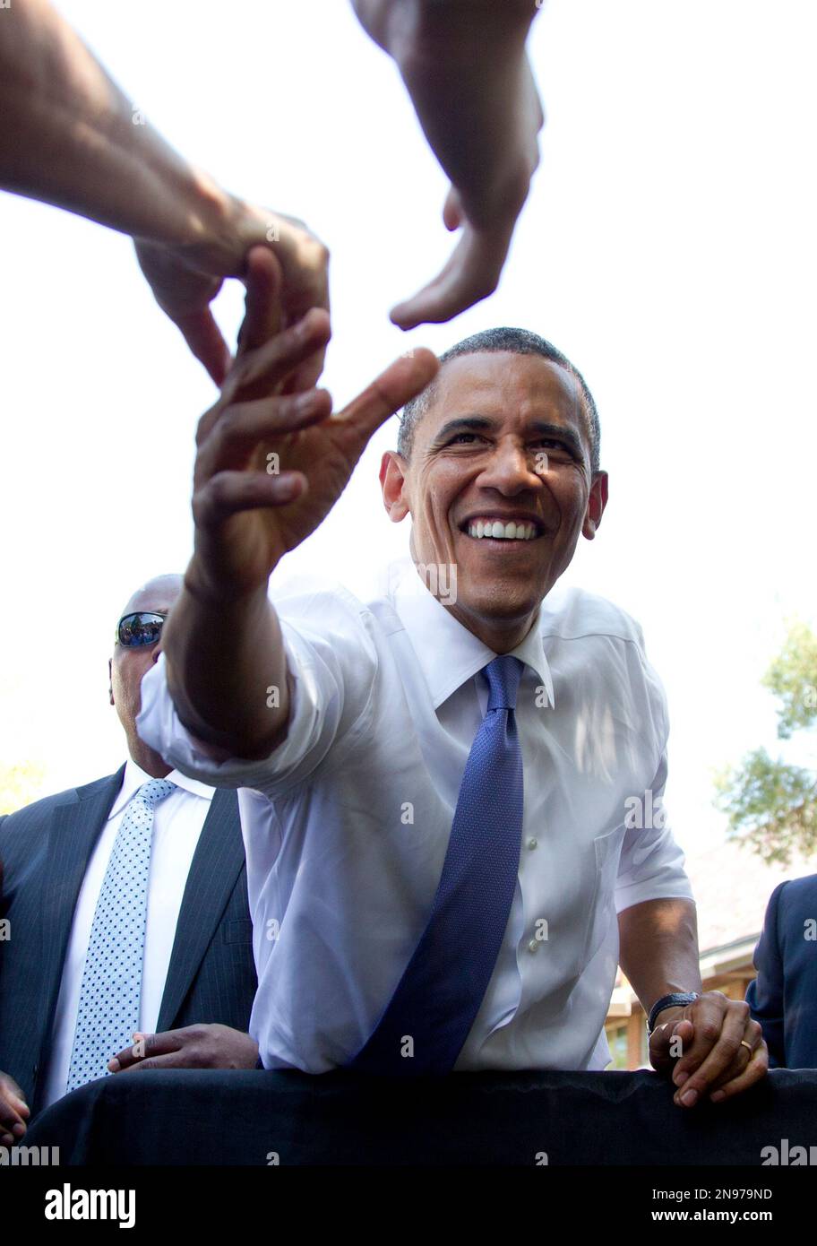 President Barack Obama reaches out to shake hands after speaking at a ...