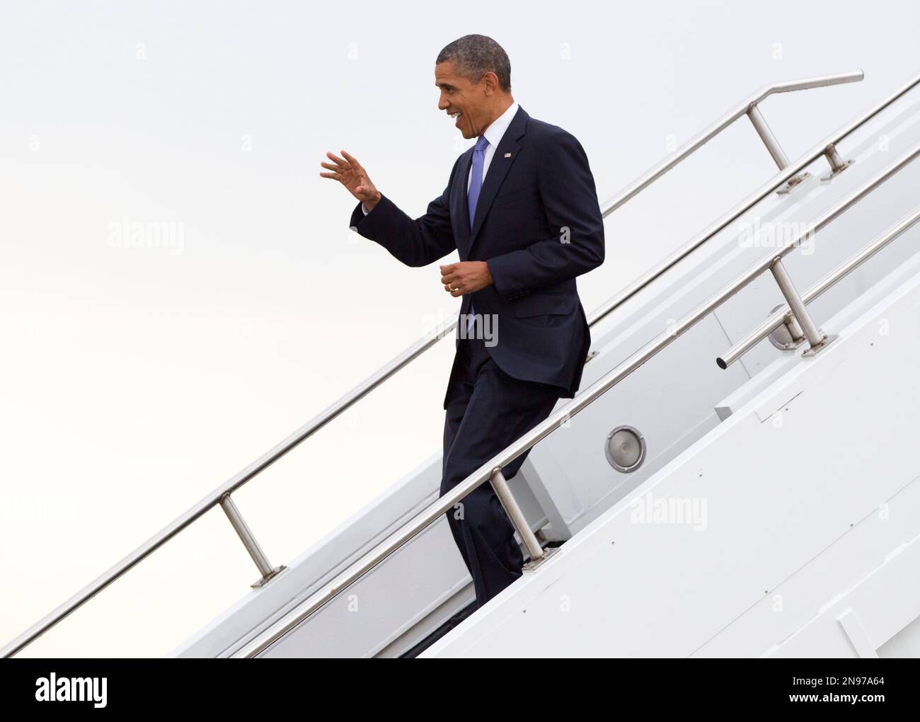 President Barack Obama waves as he arrives on Air Force One at ...