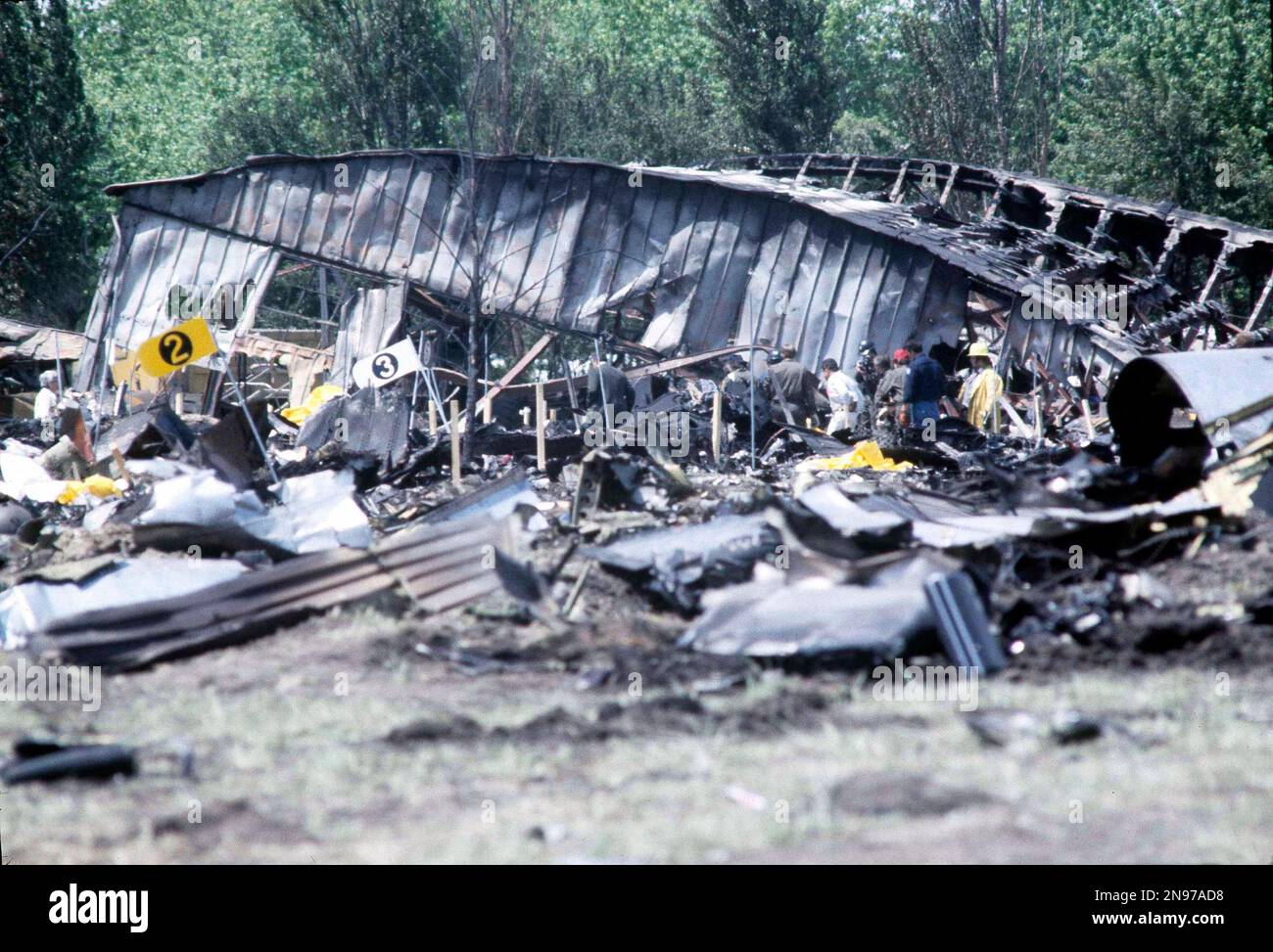 Investigators view the wreckage of the ill-fated American Airlines ...